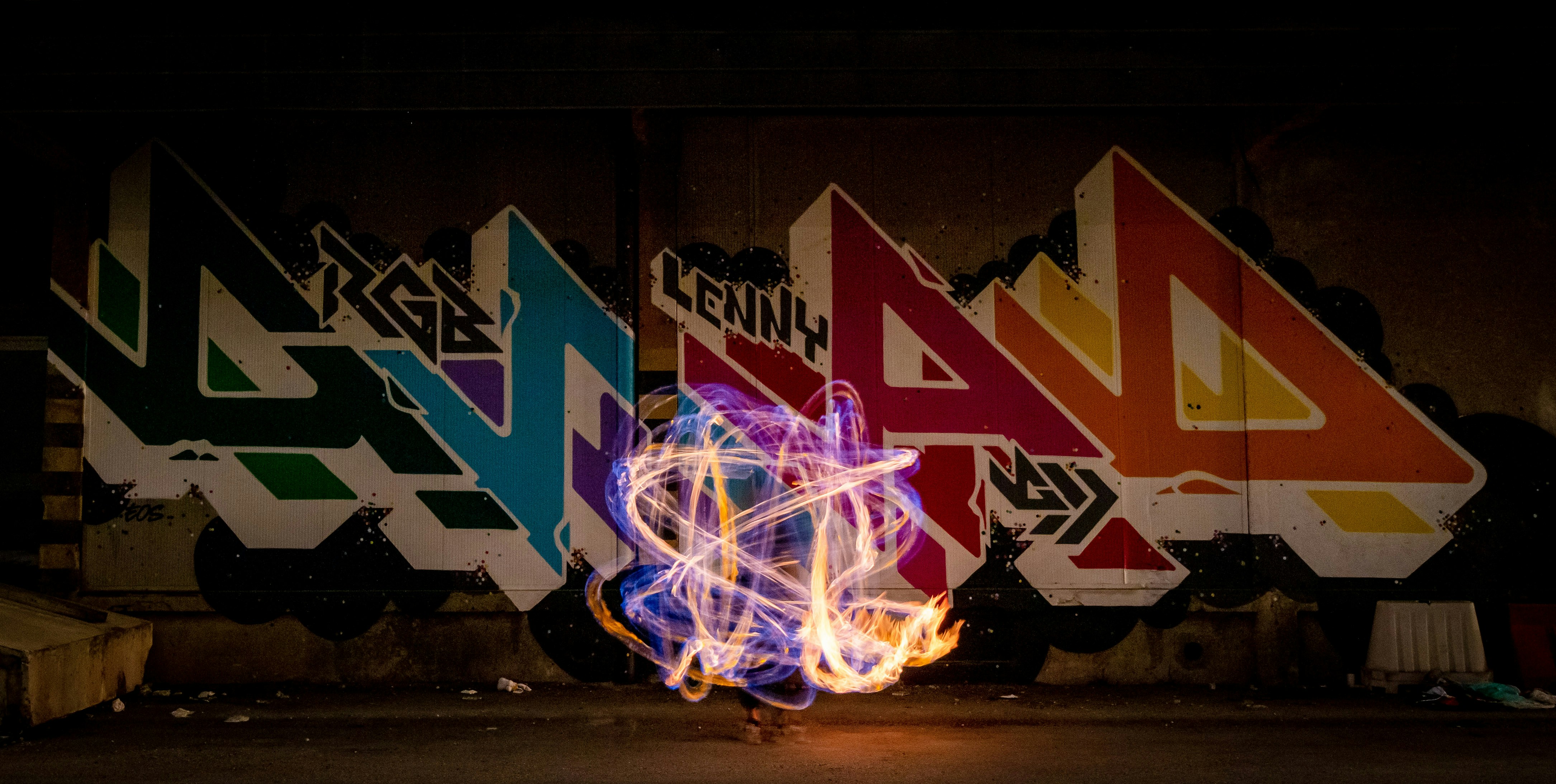 Light-Trail Serenade in Front of a Neon Graffiti Wall