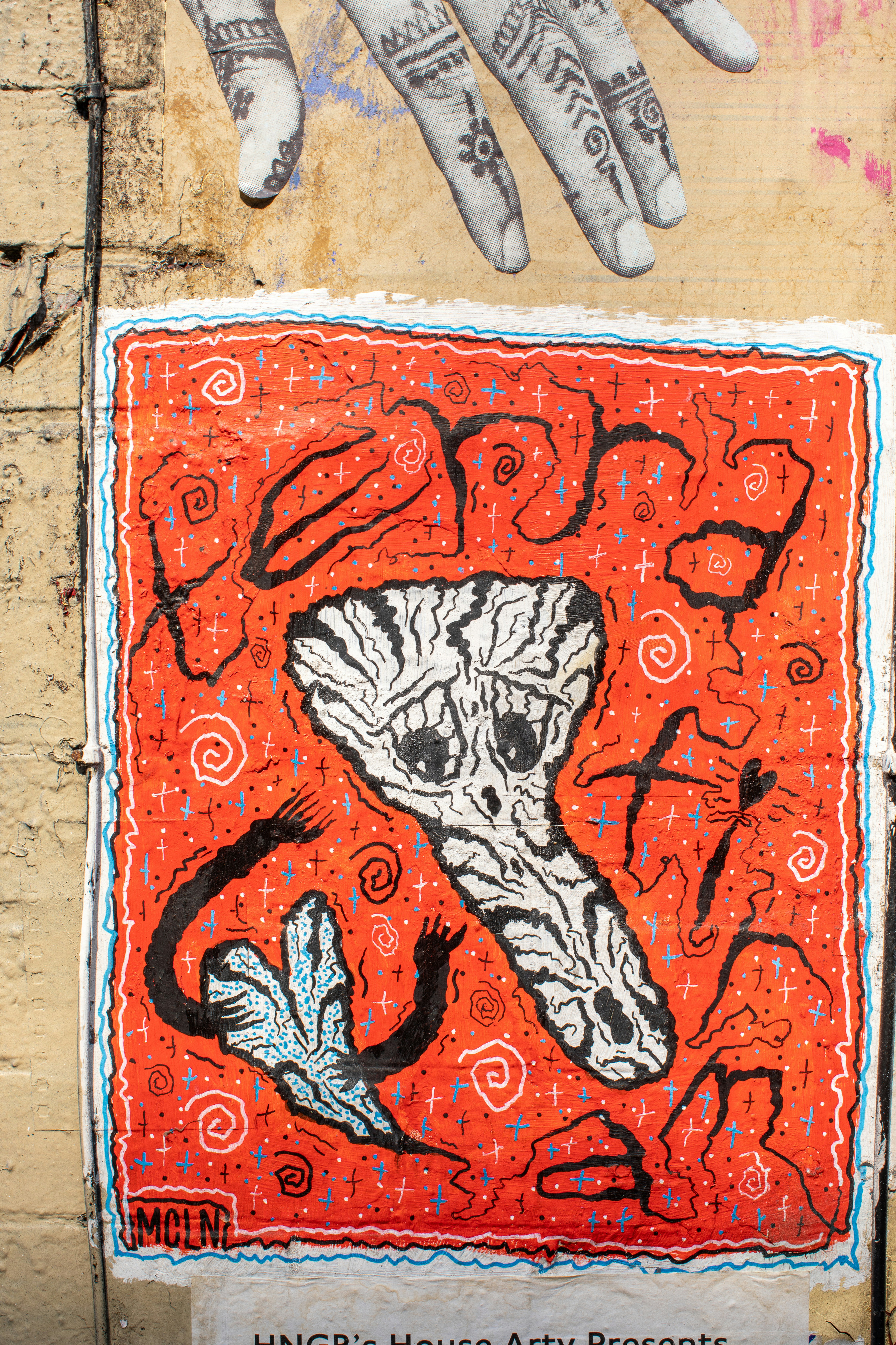 Red-orange mural frame with surreal skeletal hand motif