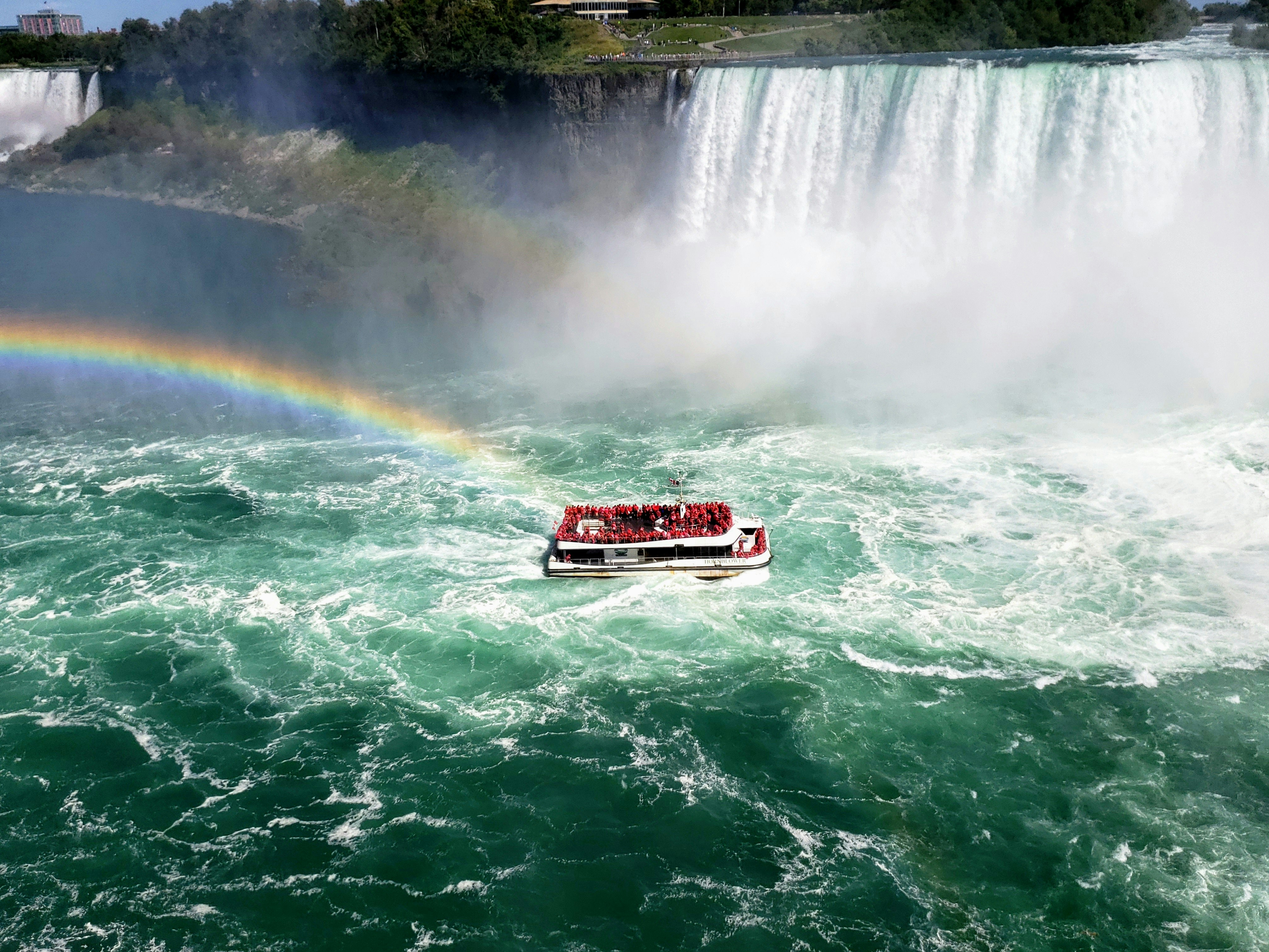 boat ride to the end of the rainbow | people on boat near falls