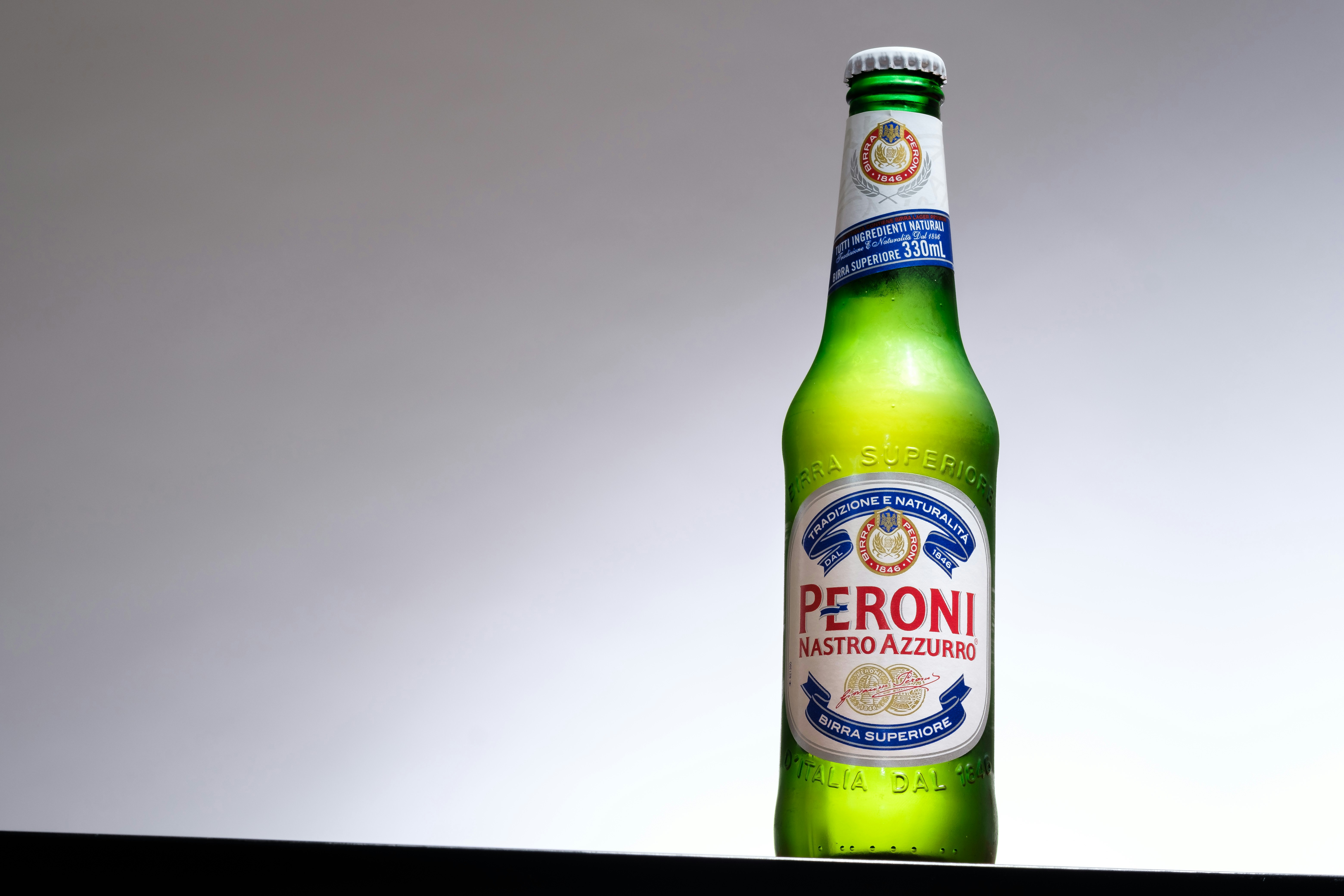 Peroni beverage bottle on black surface photo – Free Sydney Image on ...