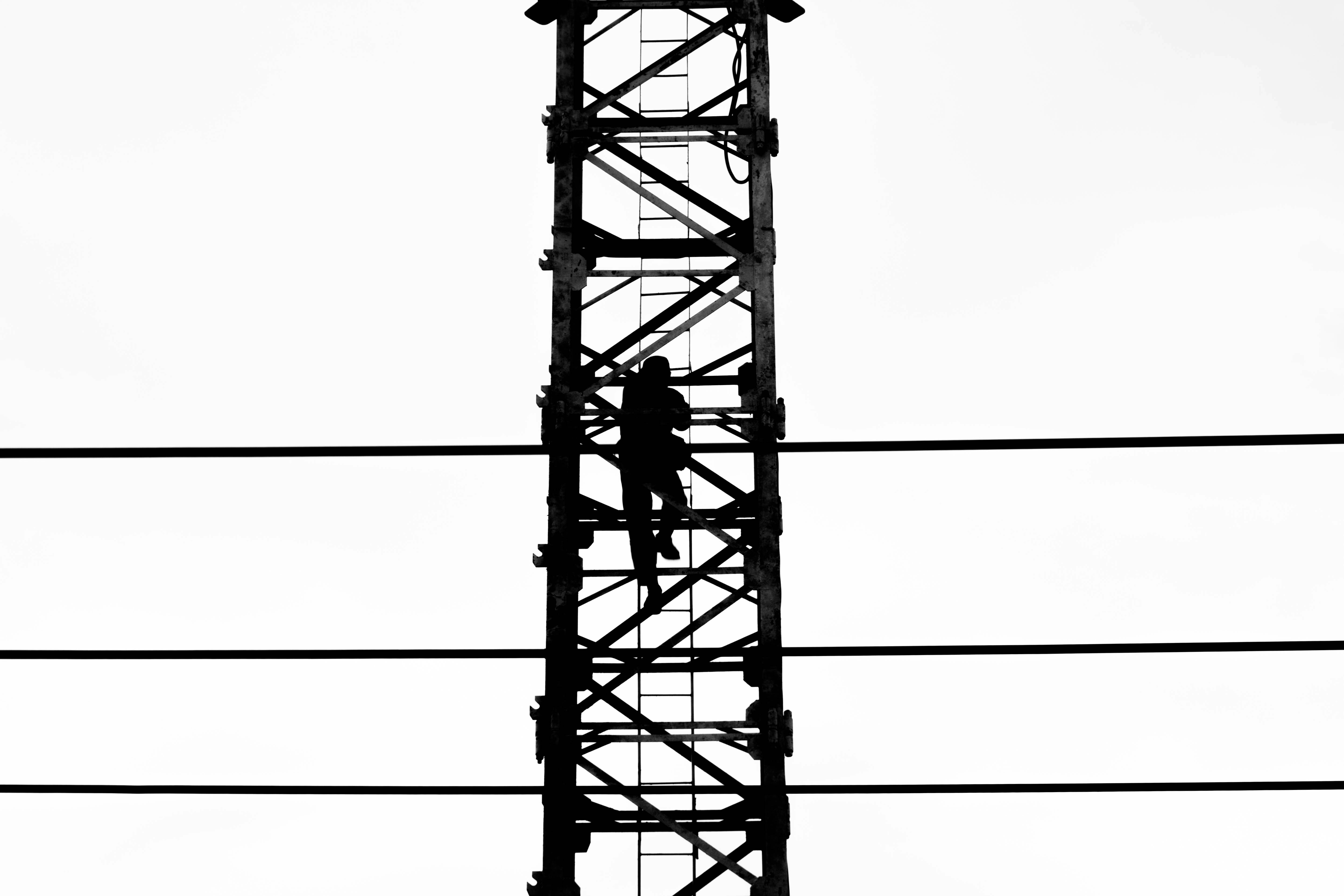Person climbing on tower illustration photo – Free Black Image on Unsplash