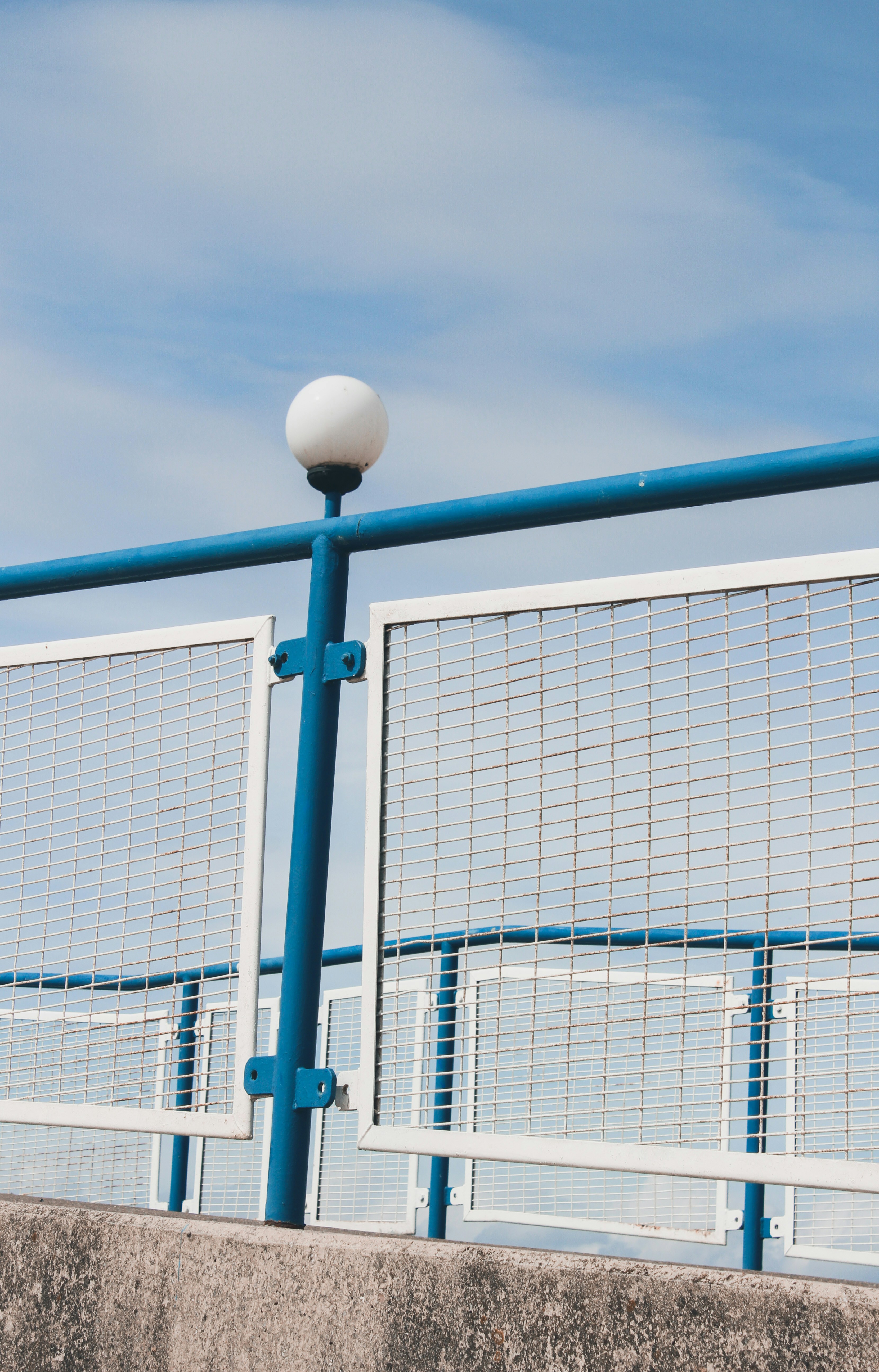 white and blue metal fence