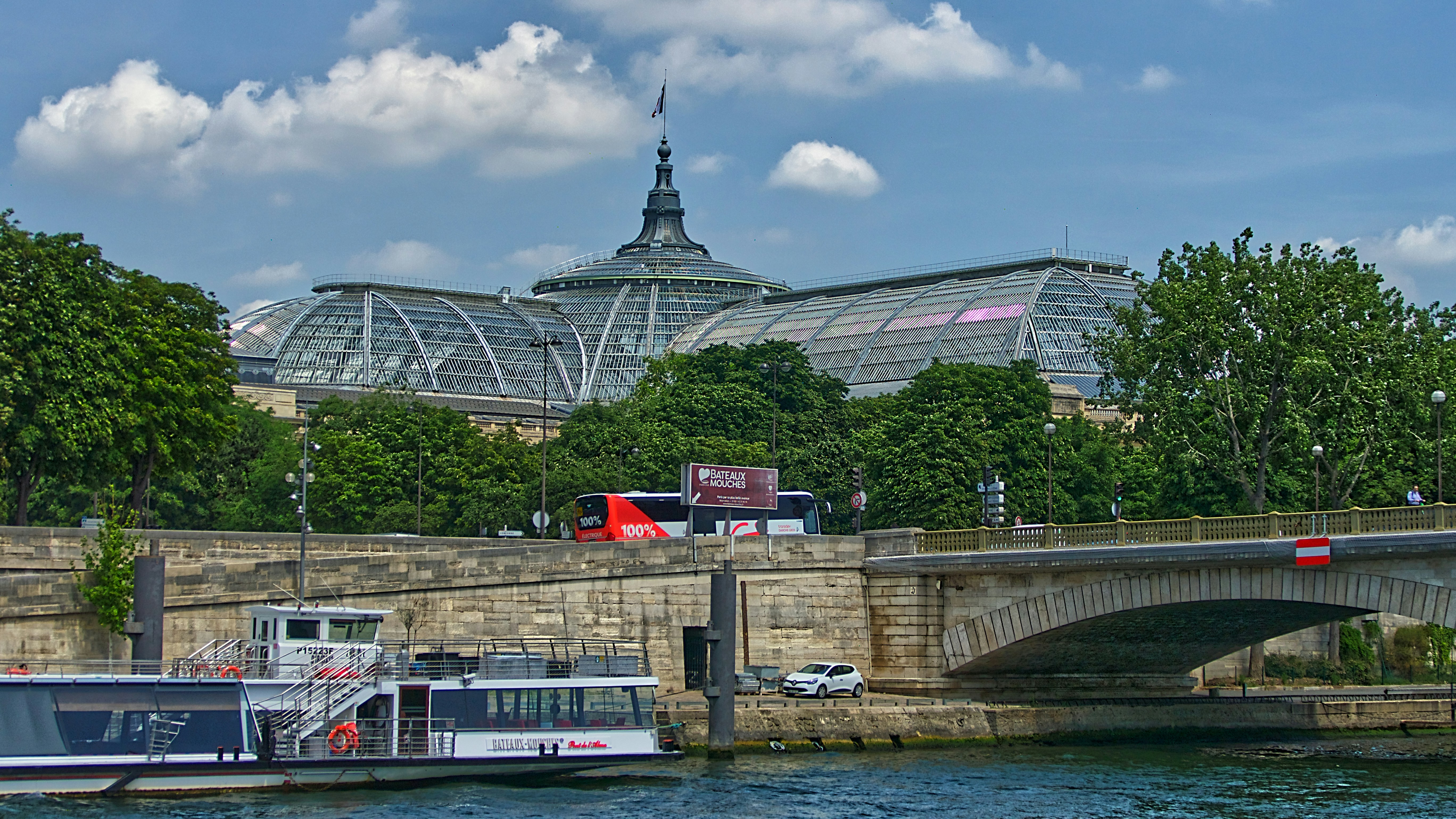 Riverbank Transit Under a Glass-Top Conservatory