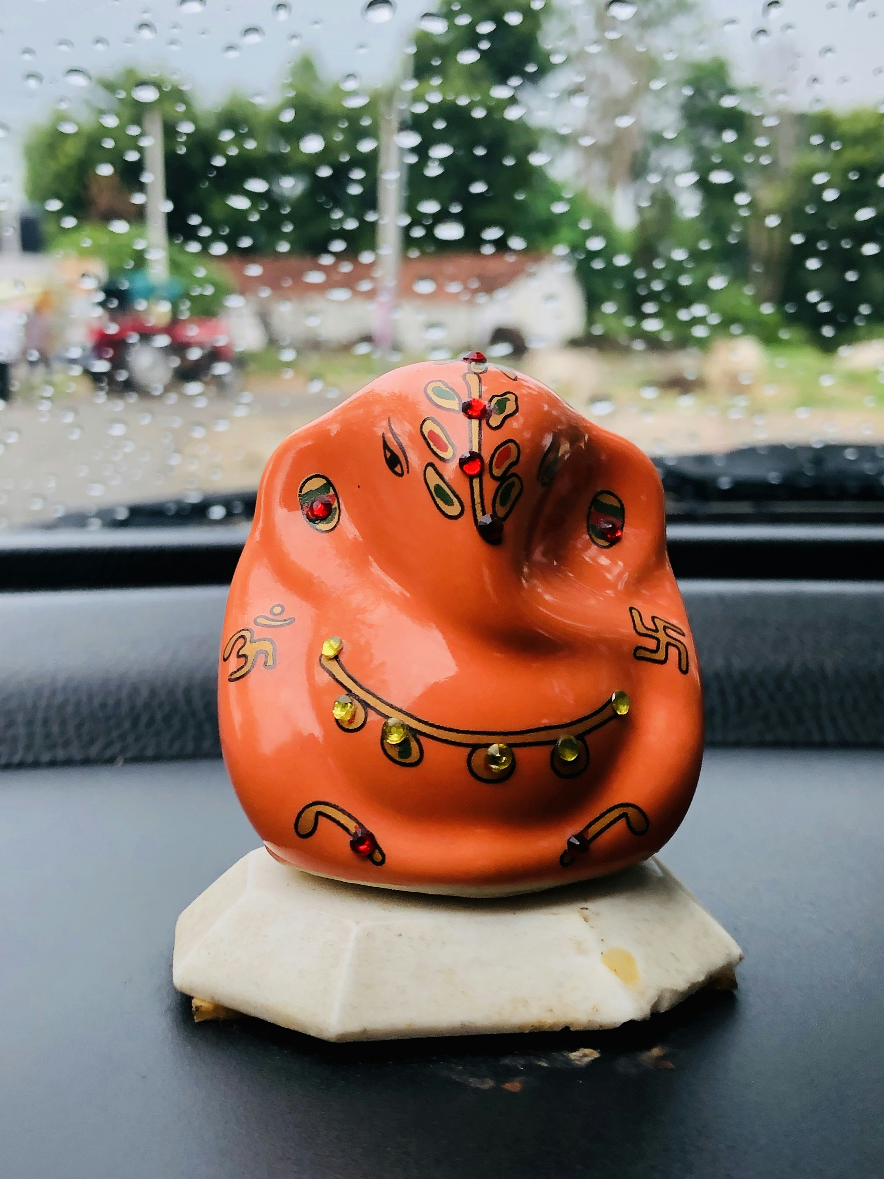 Lord Ganesha Statue in front desk of car.