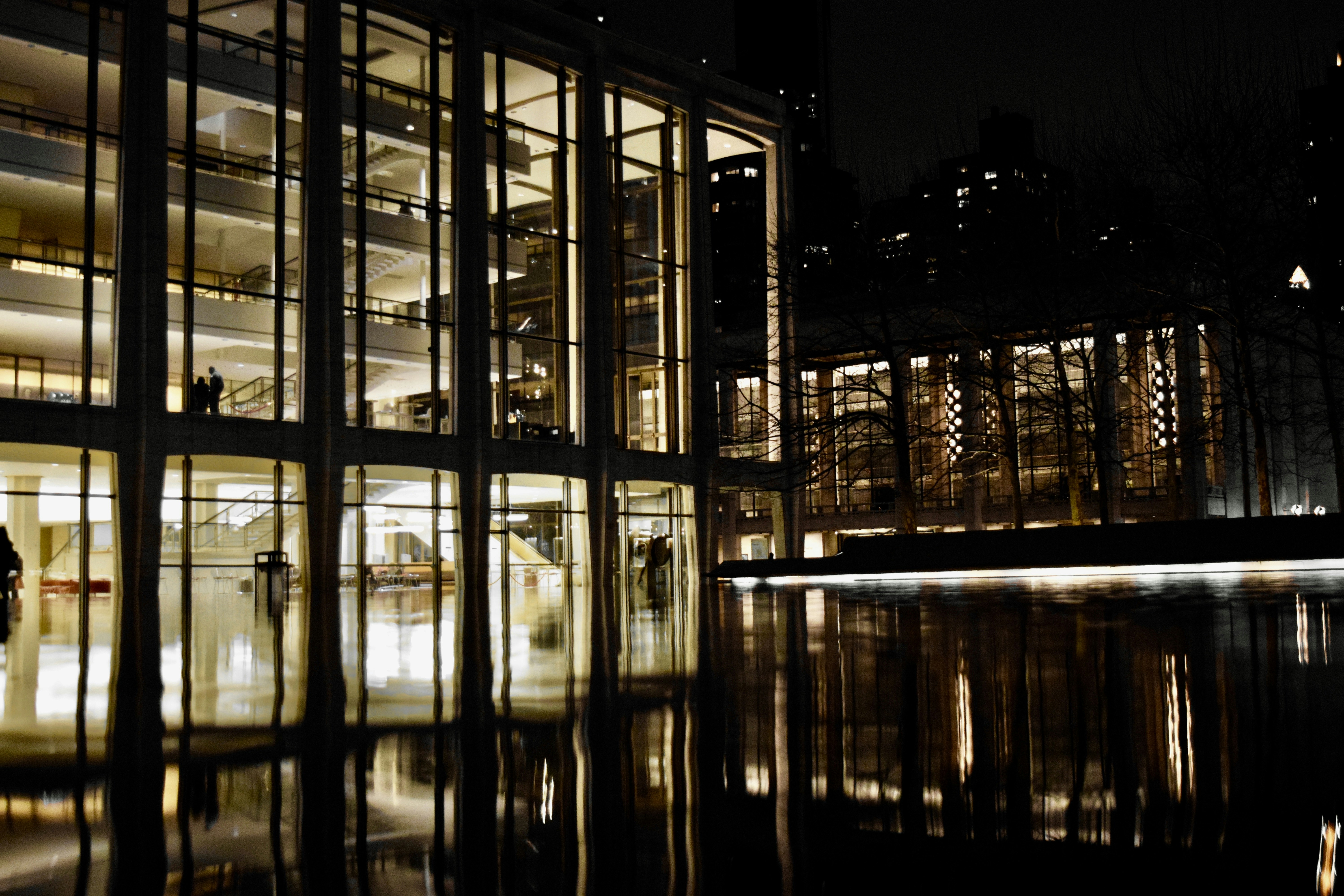 Body of water across building with lights photo – Free Building Image ...