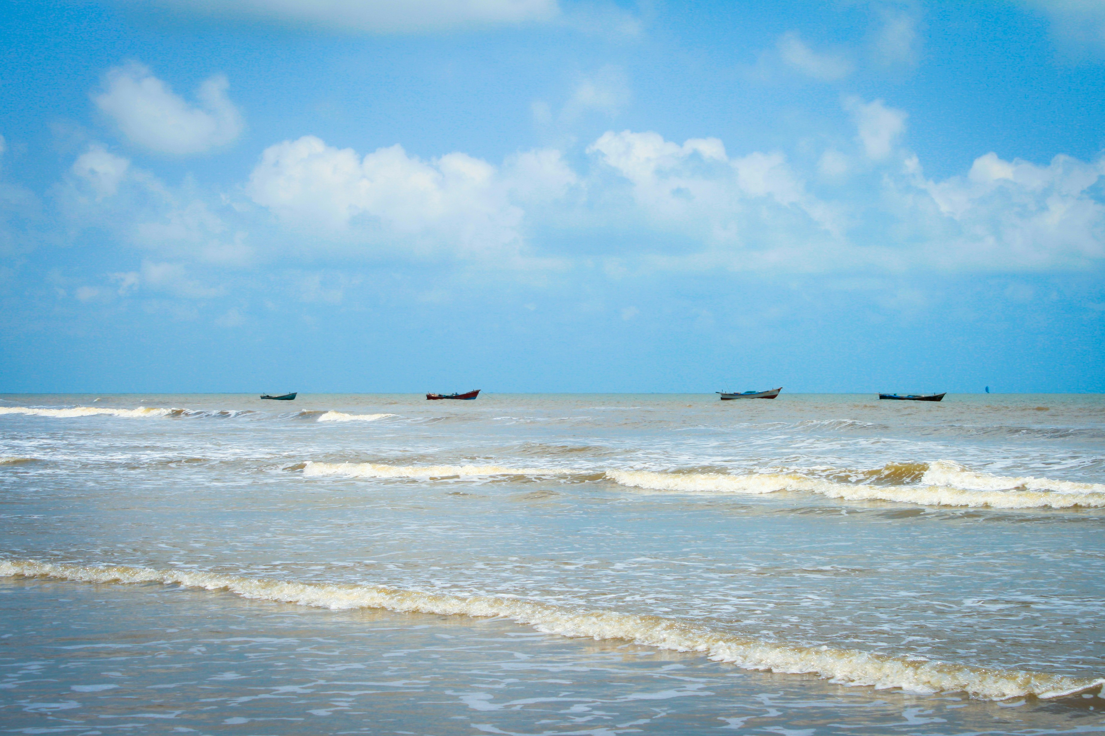 Serene Horizon: Boats on a Tranquil SeaBharath Reddy