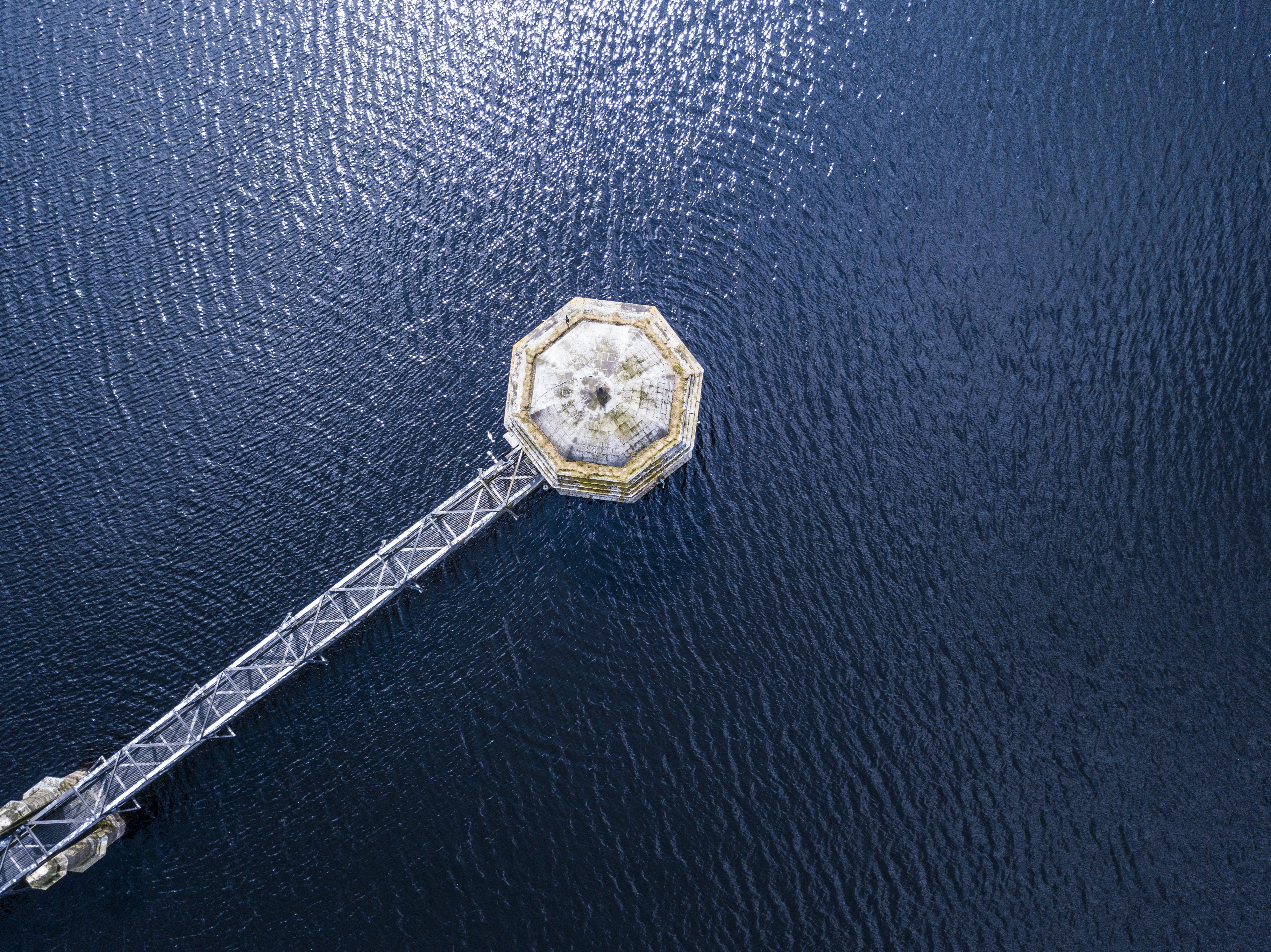 End-of-Pier Octagon: Aerial beacon slicing through a cobalt sea