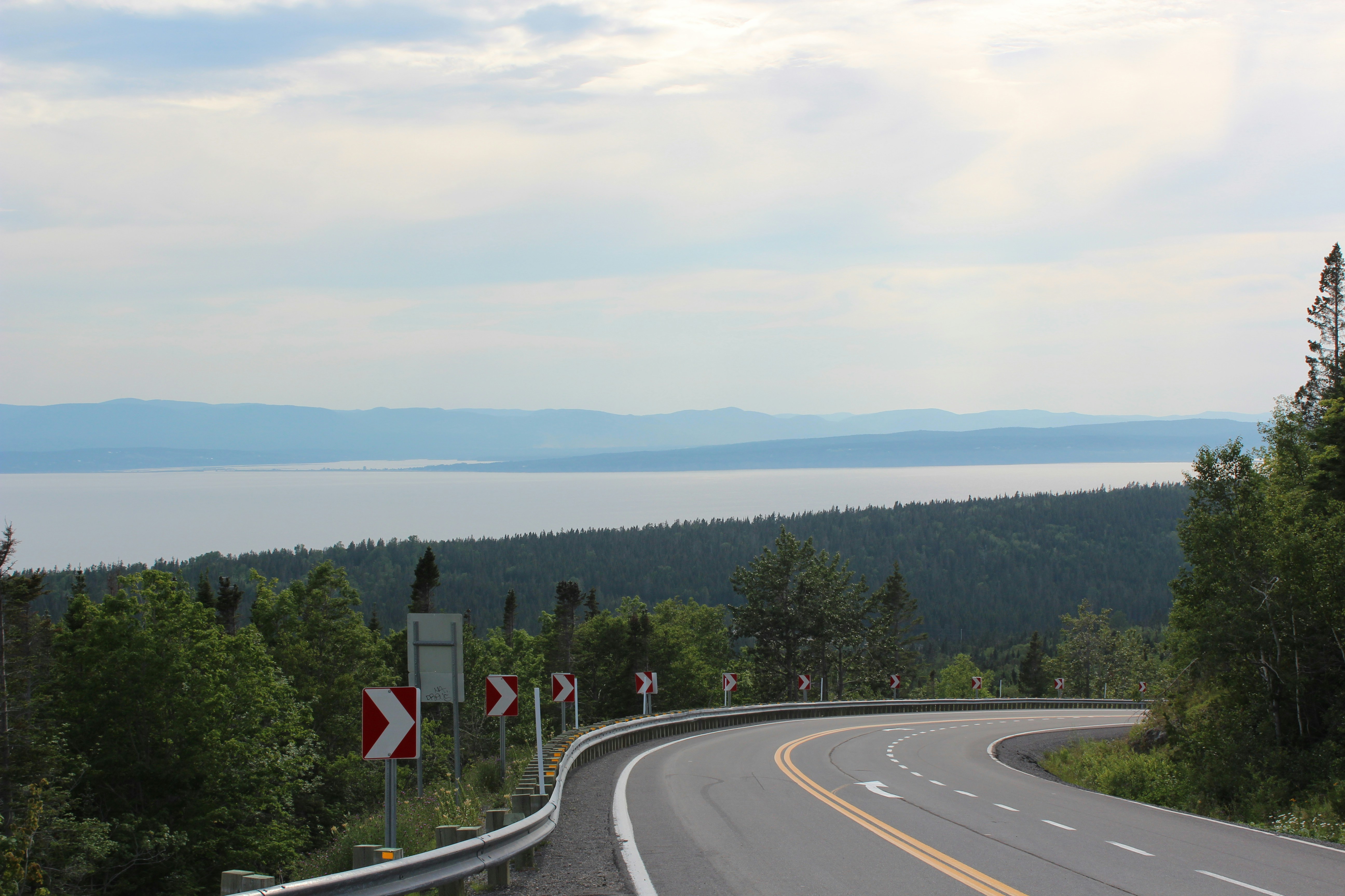 Curved Coastal Road toward a Distant Blue Horizon