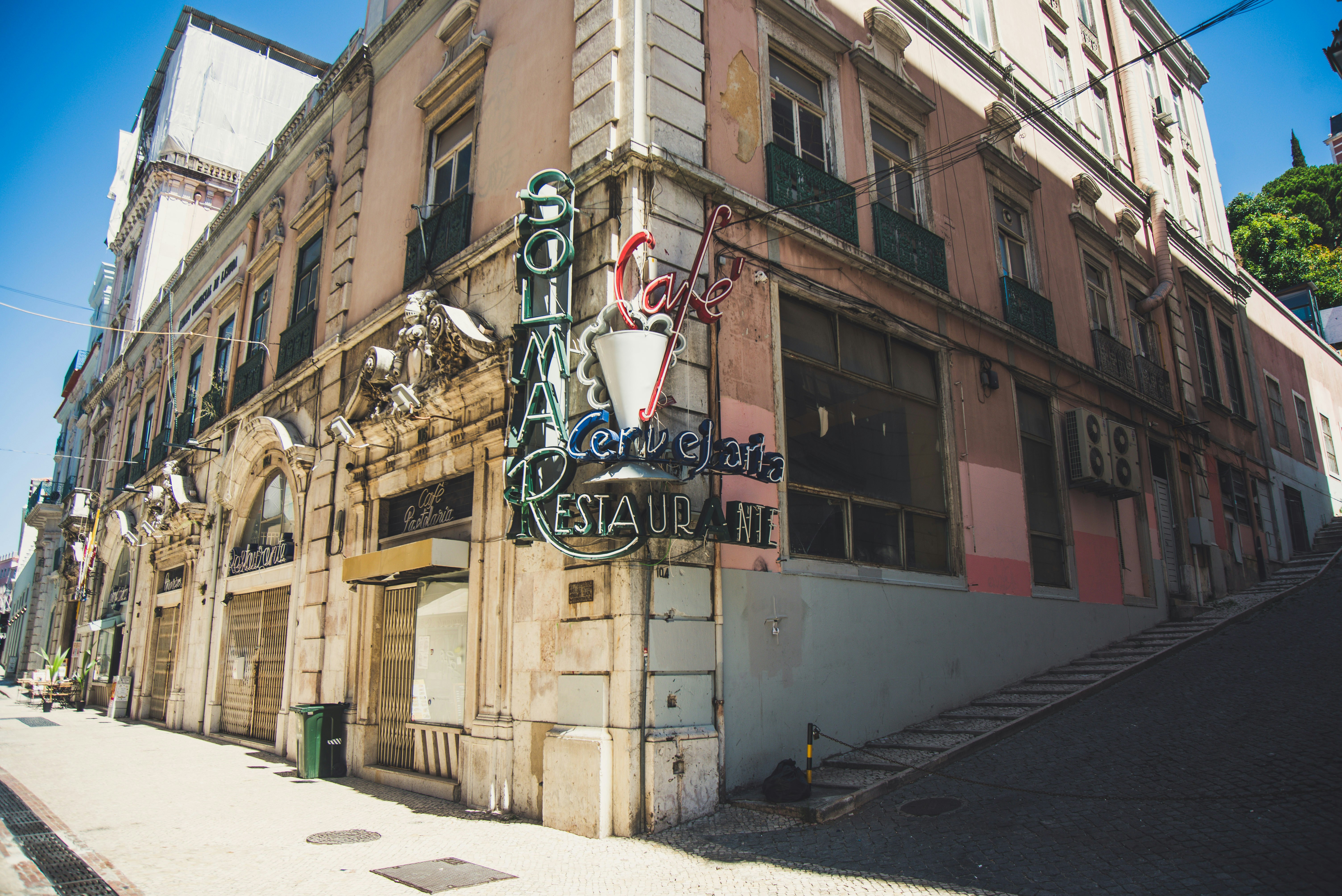 Vintage café sign and weathered façade of Solmar, showcasing the charm of historical architecture in an urban setting.
