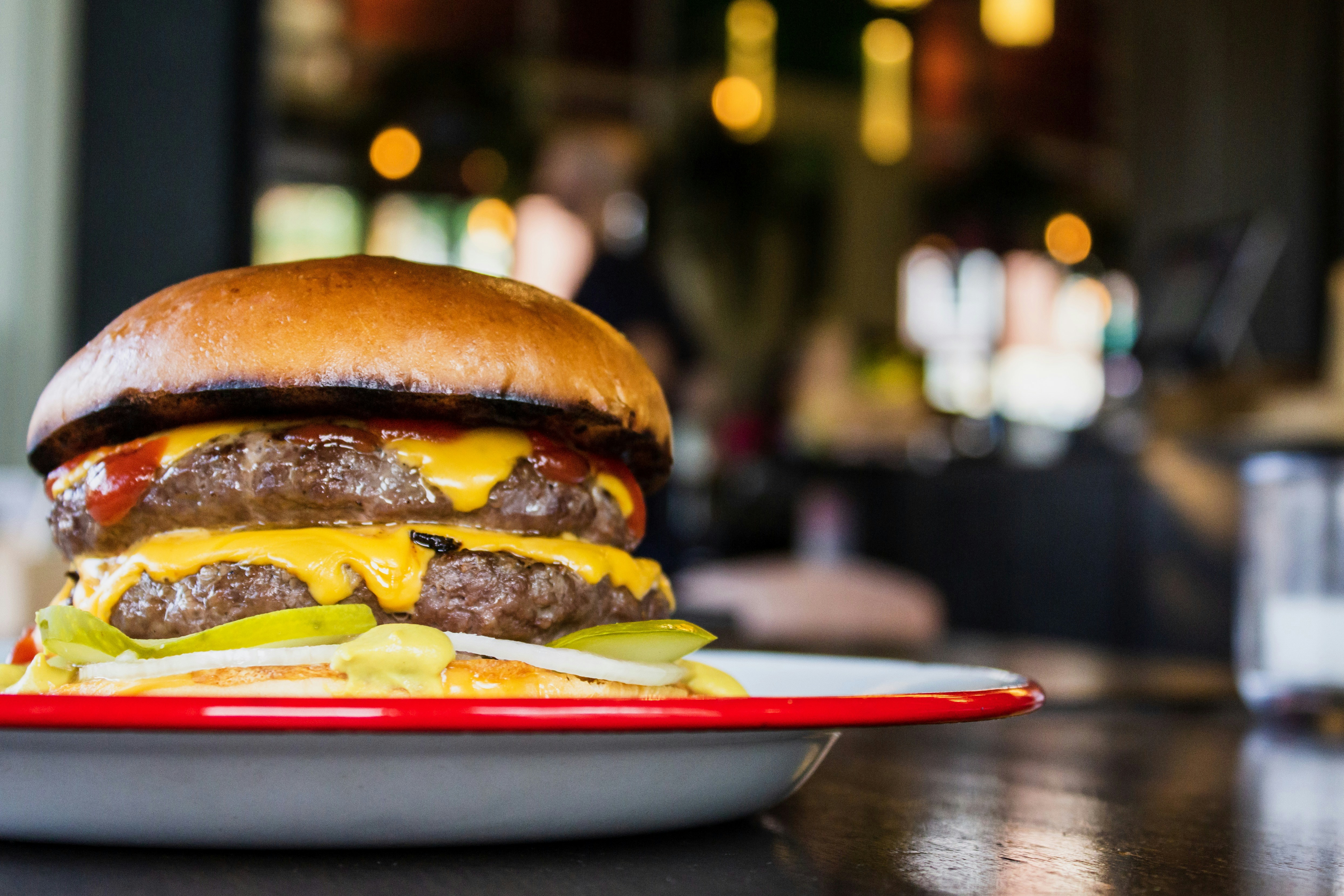 Hamburger on white plate close-up photography photo – Free Burger Image ...