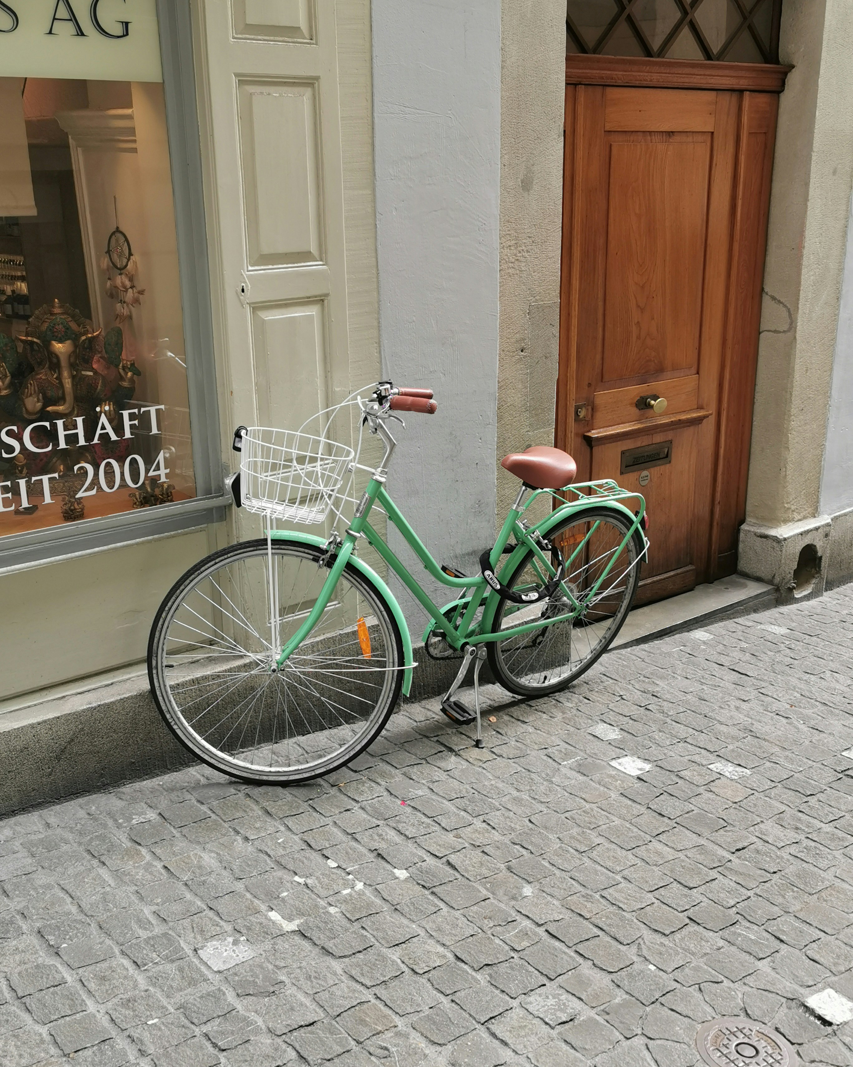 Green Bicycle by a Quiet Doorstep