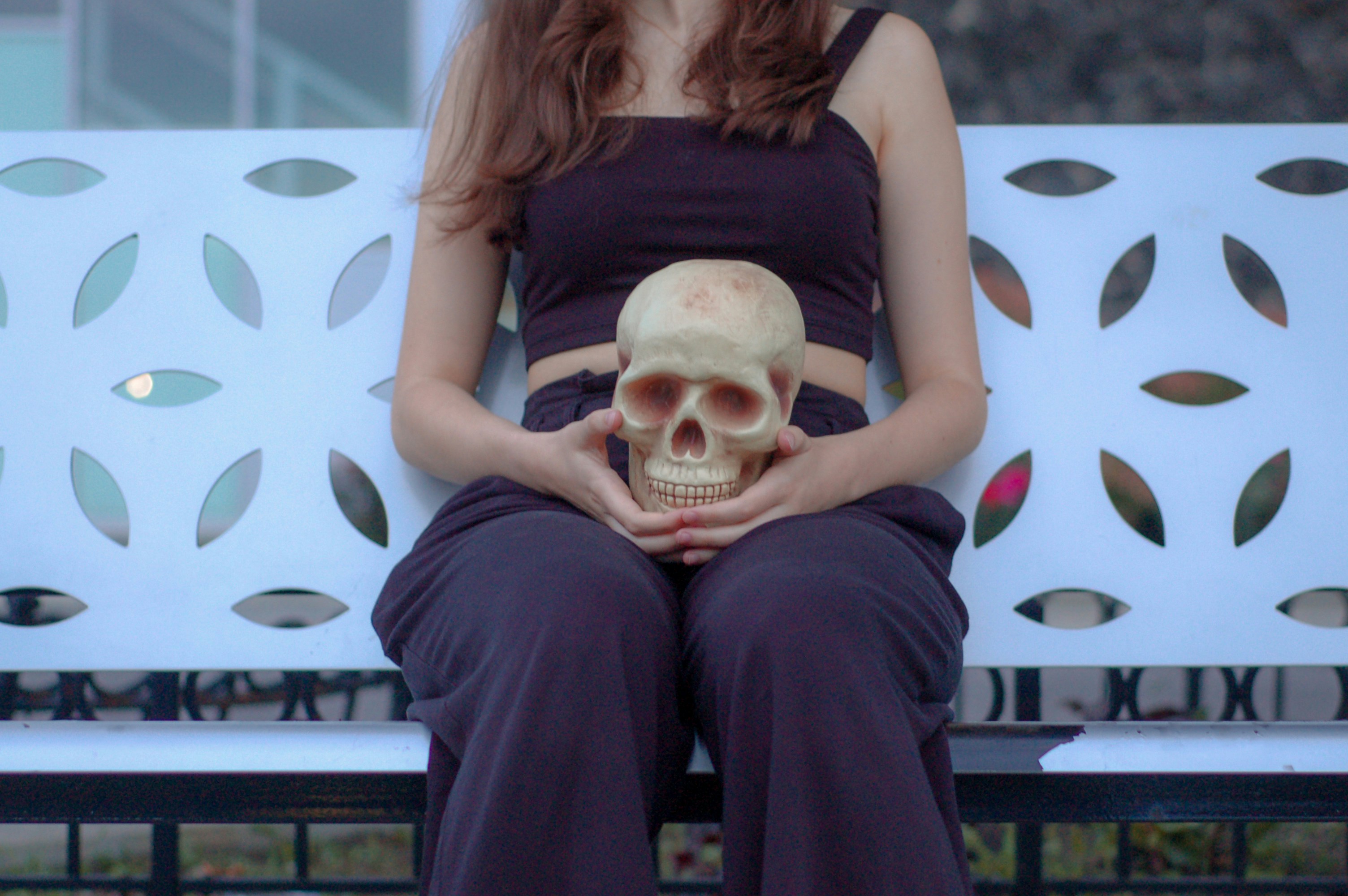 Woman carrying human skull sitting on bench outdoors photo – Free Woman ...