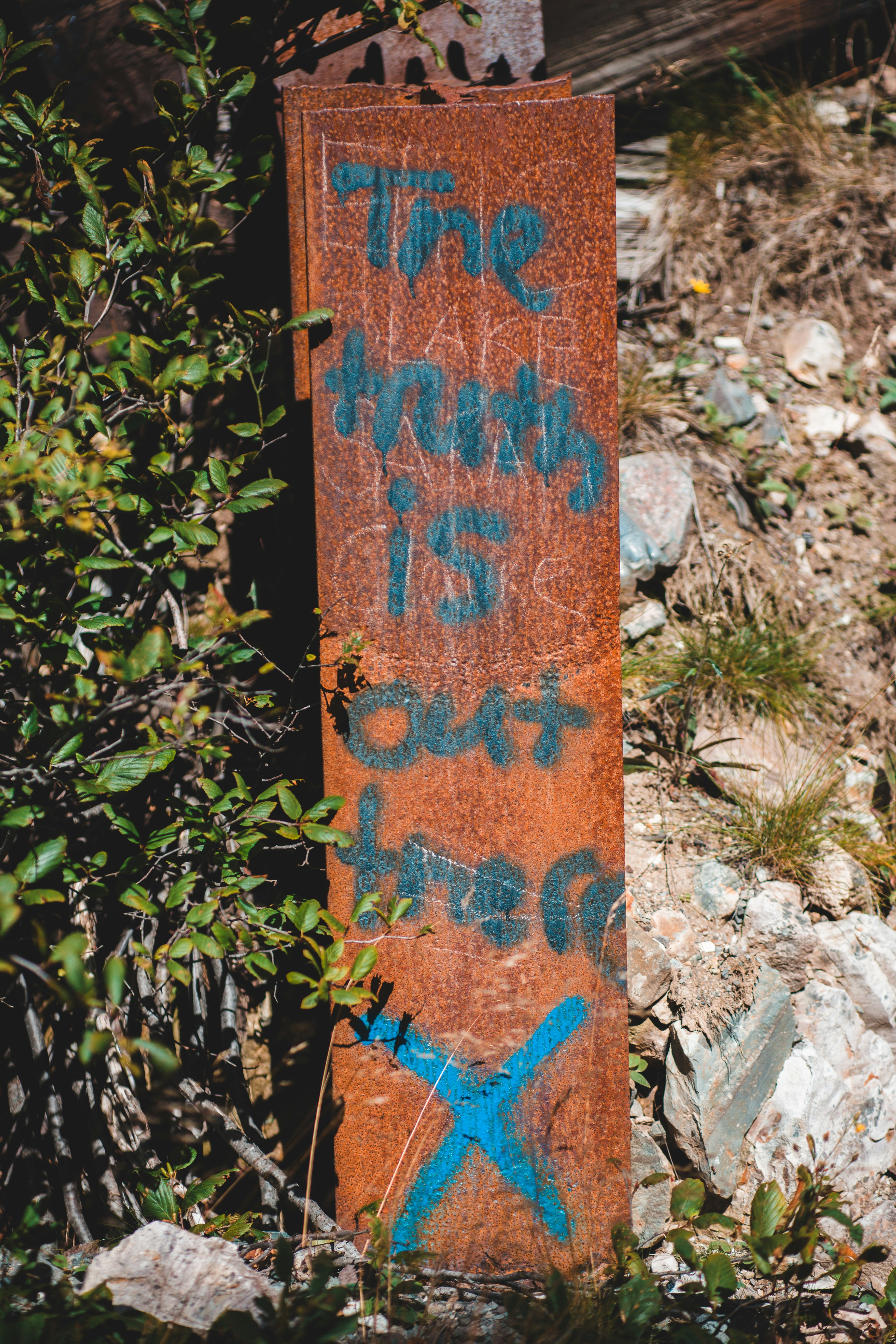 The Truth on a Rusted Post in a Rocky Verge