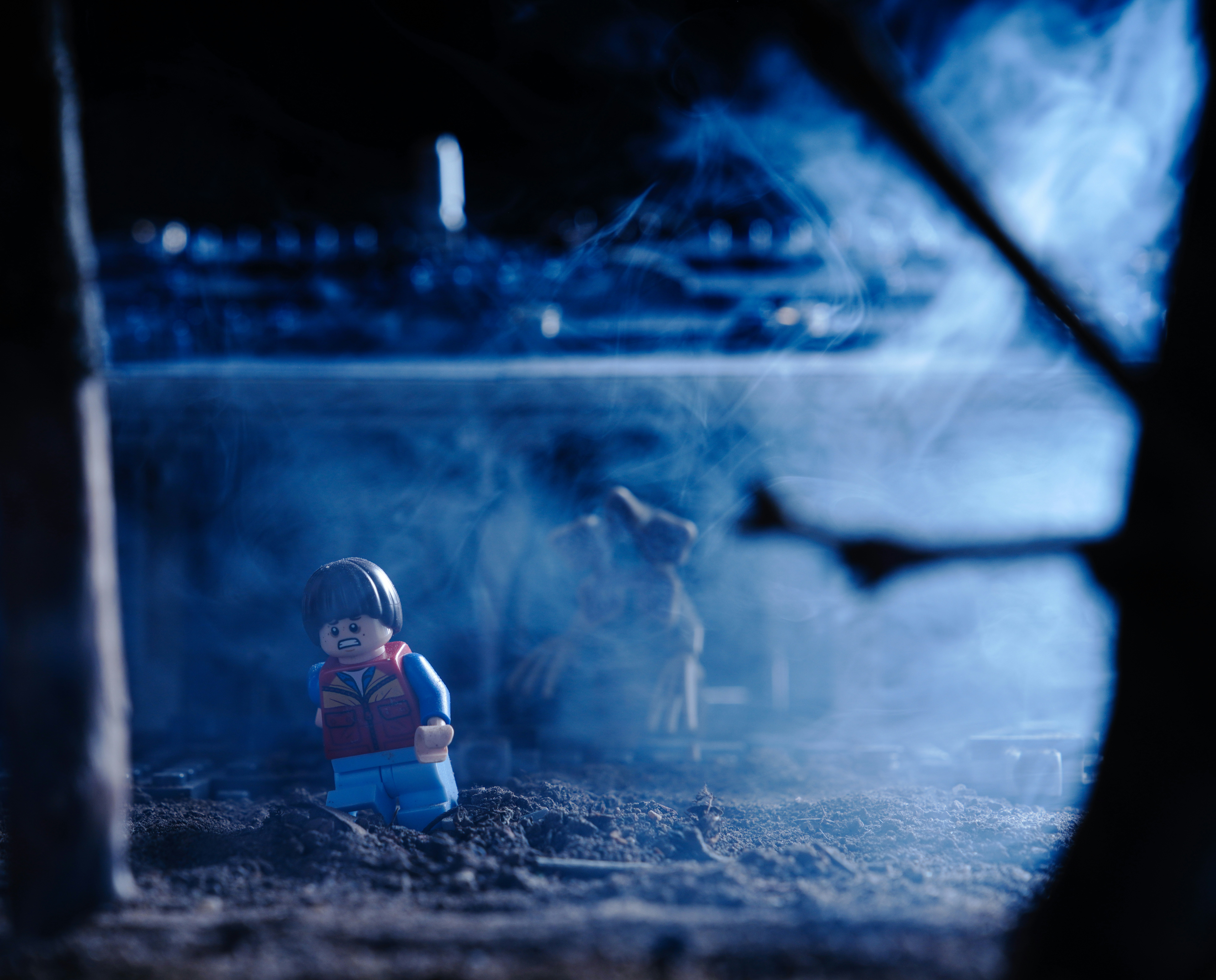 A lego man sitting in the middle of a field photo – Free Blue Image on ...