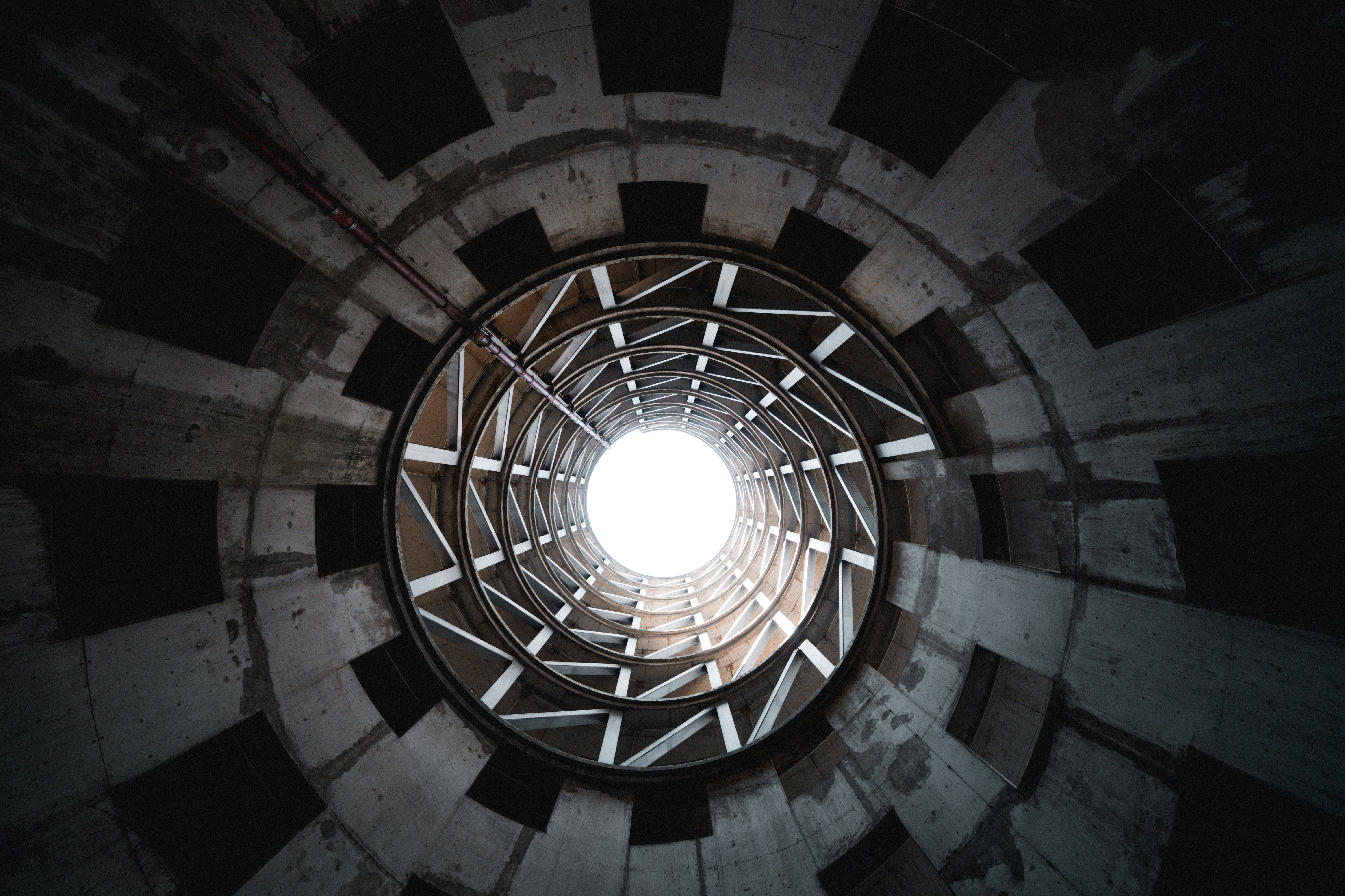 A round window in the center of a concrete structure photo – Free Grey ...