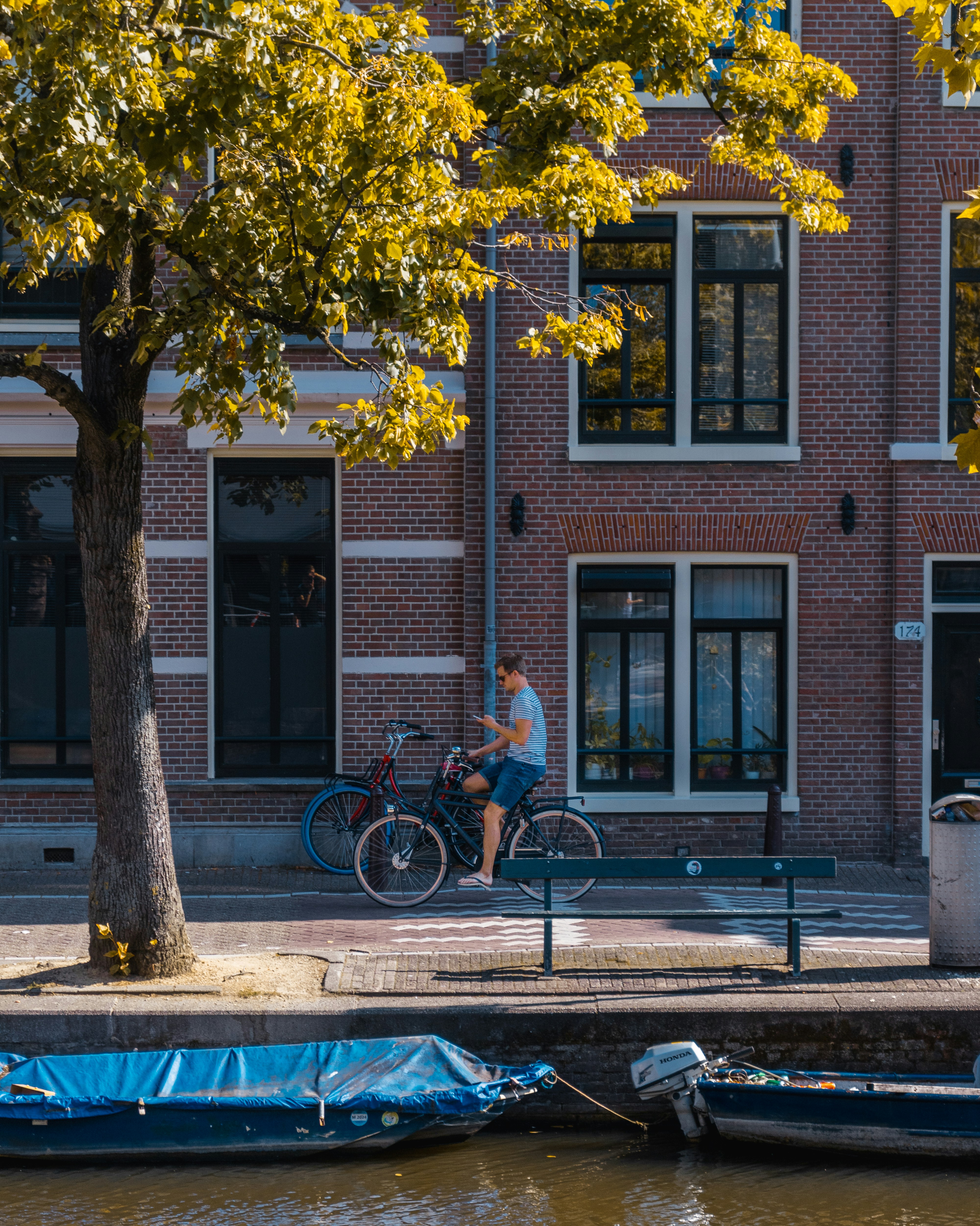 Cyclist in a Quiet Canal Street Courtyard