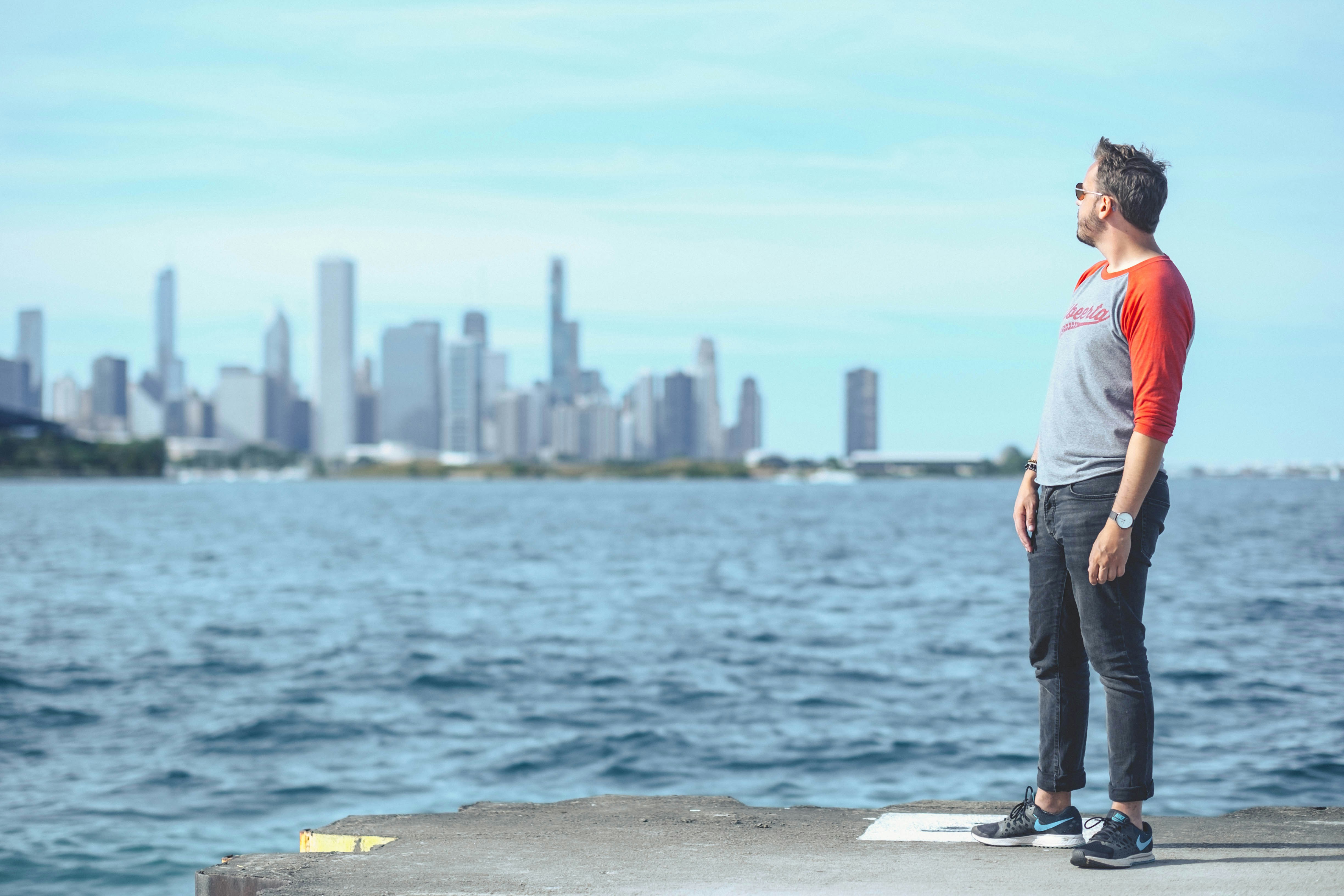 Rooftop Gaze: A Man Standing at the Edge of the Water