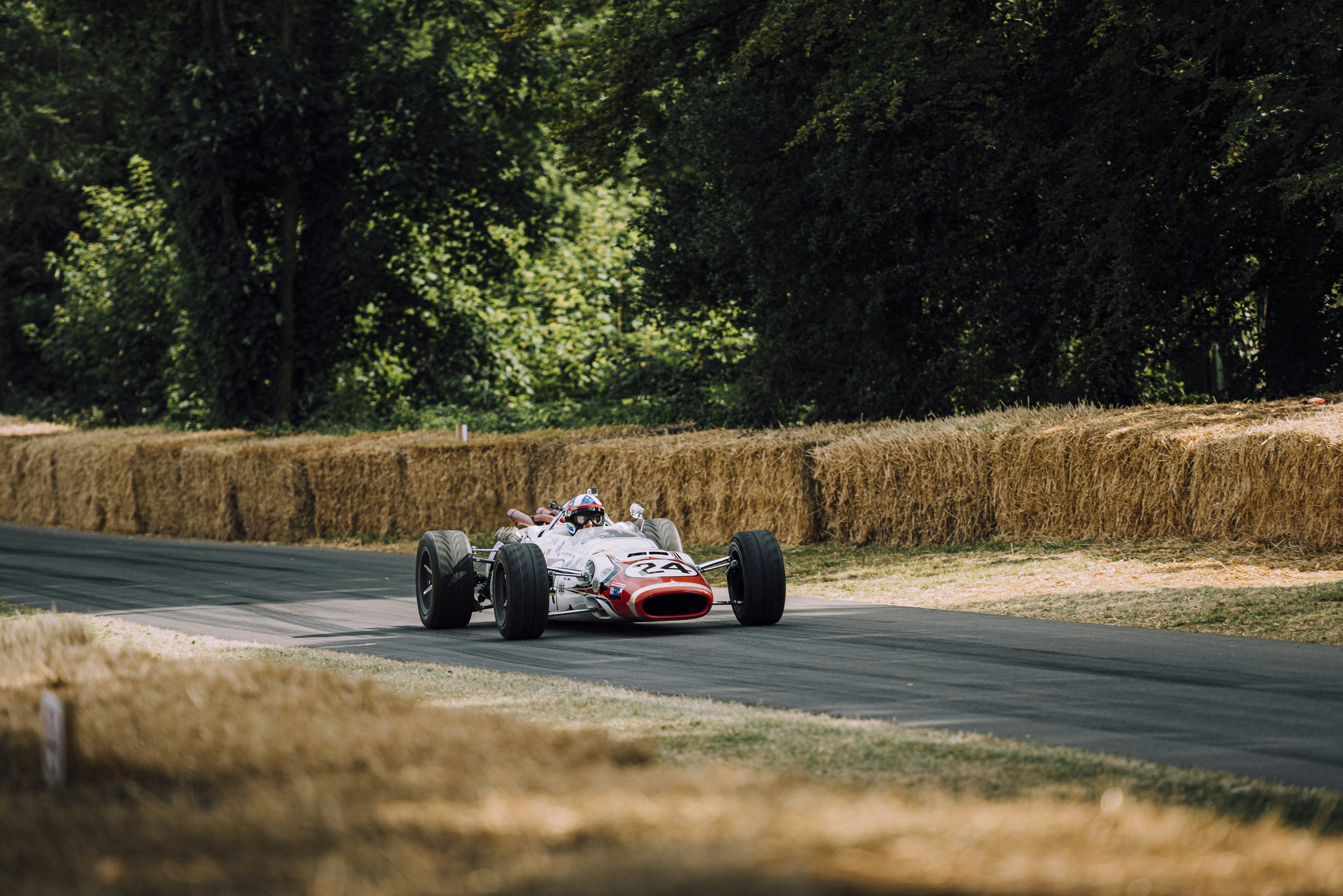 Person riding racing car on road photo – Free Machine Image on Unsplash