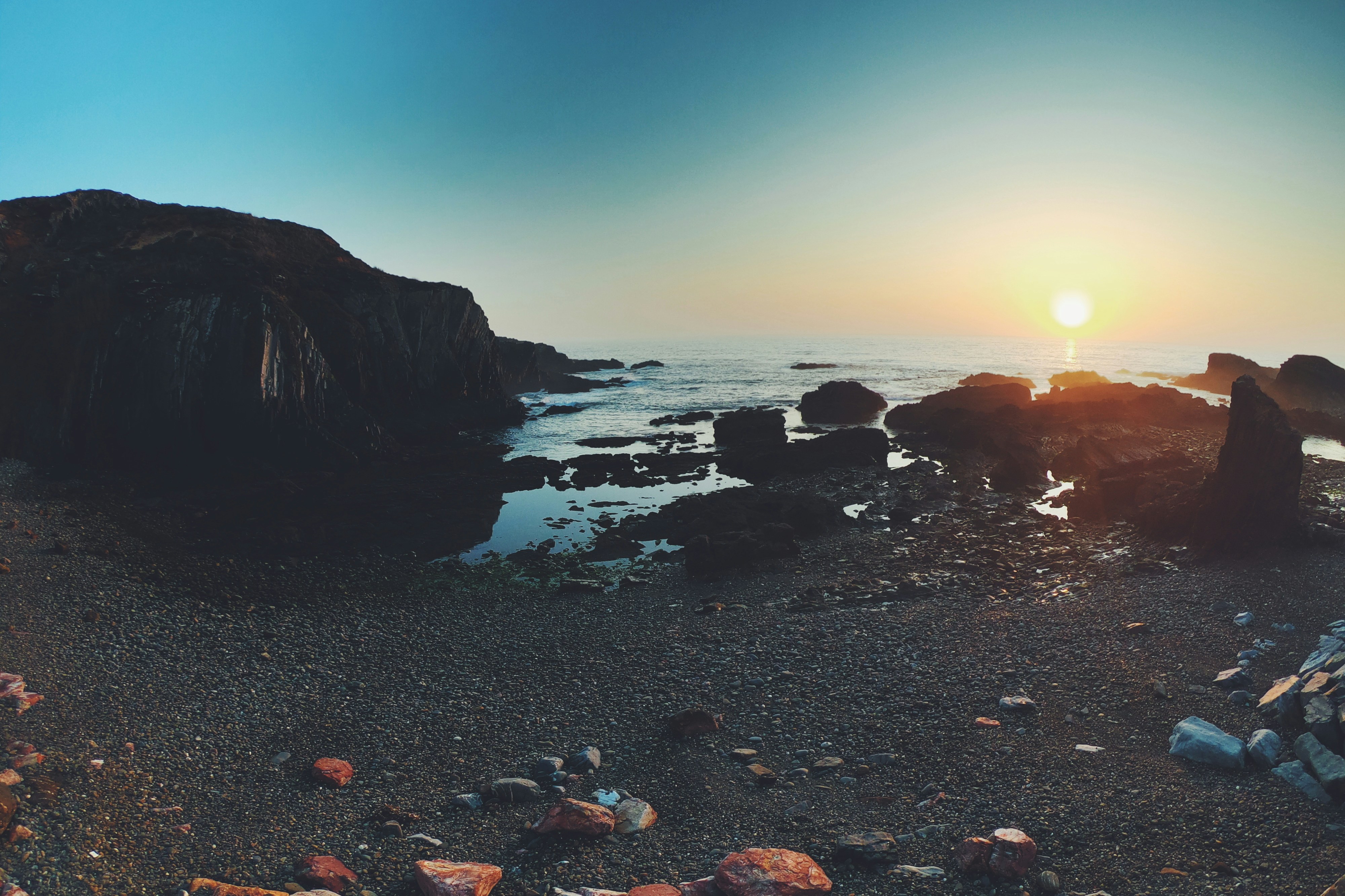 Sunlit shoreline under a quiet horizon
