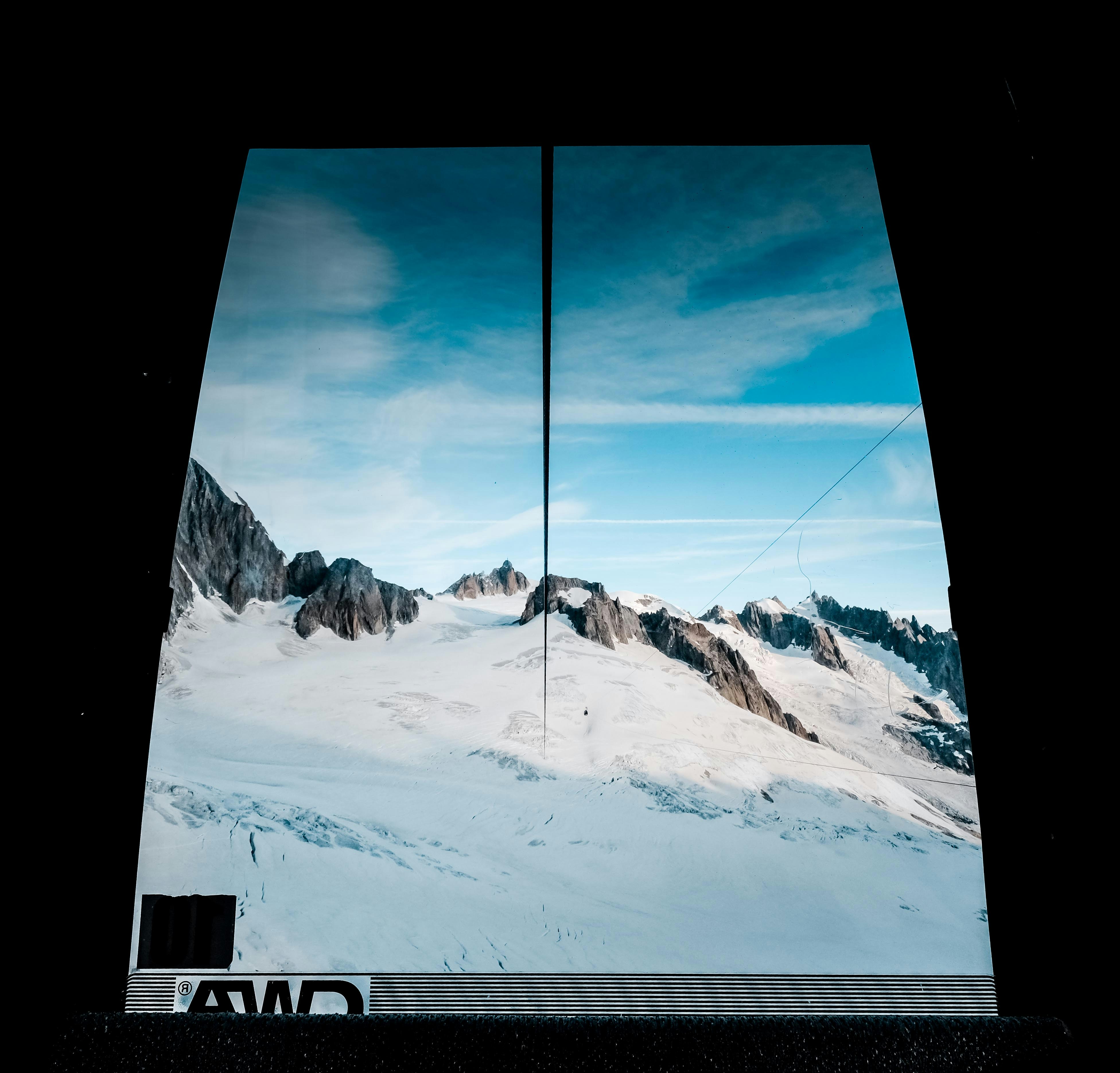 Glacial Window: Snow-Crowned Peaks Through a Framed Aperture