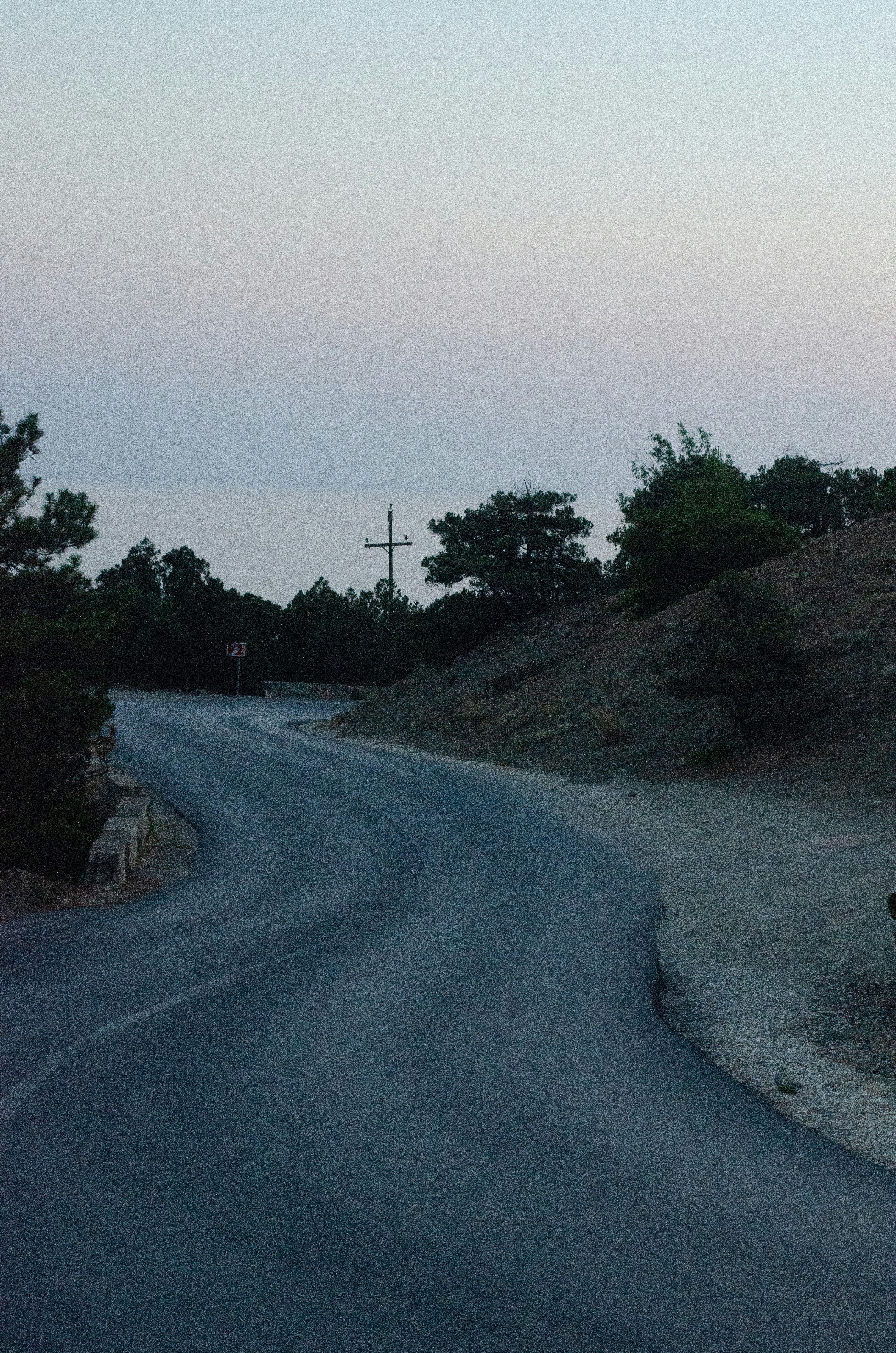 Pastel Dusk Curve: A Quiet Road Winding Through Hills