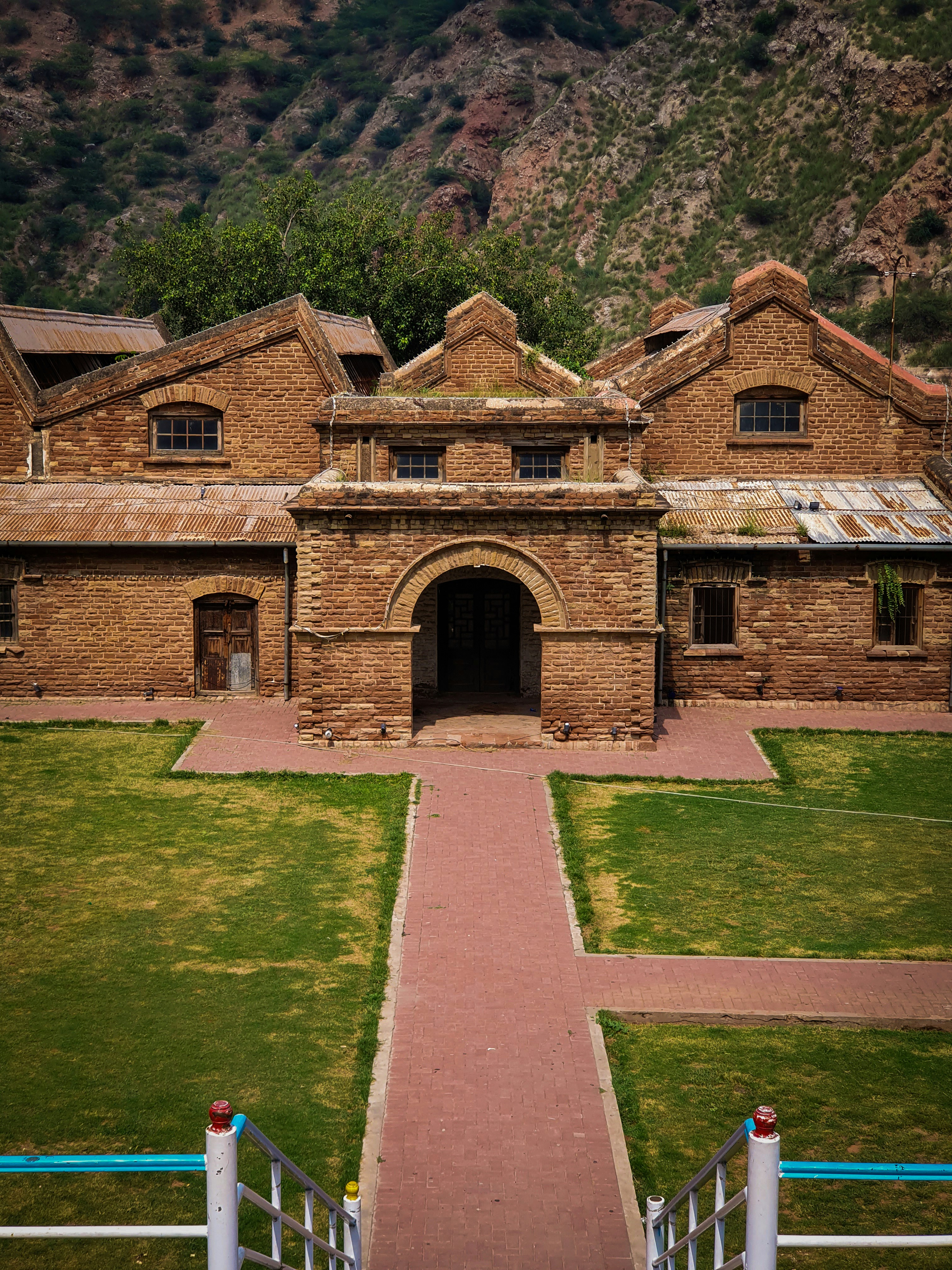 Red Brick Archway Courtyard Framing a Mountain Backdrop