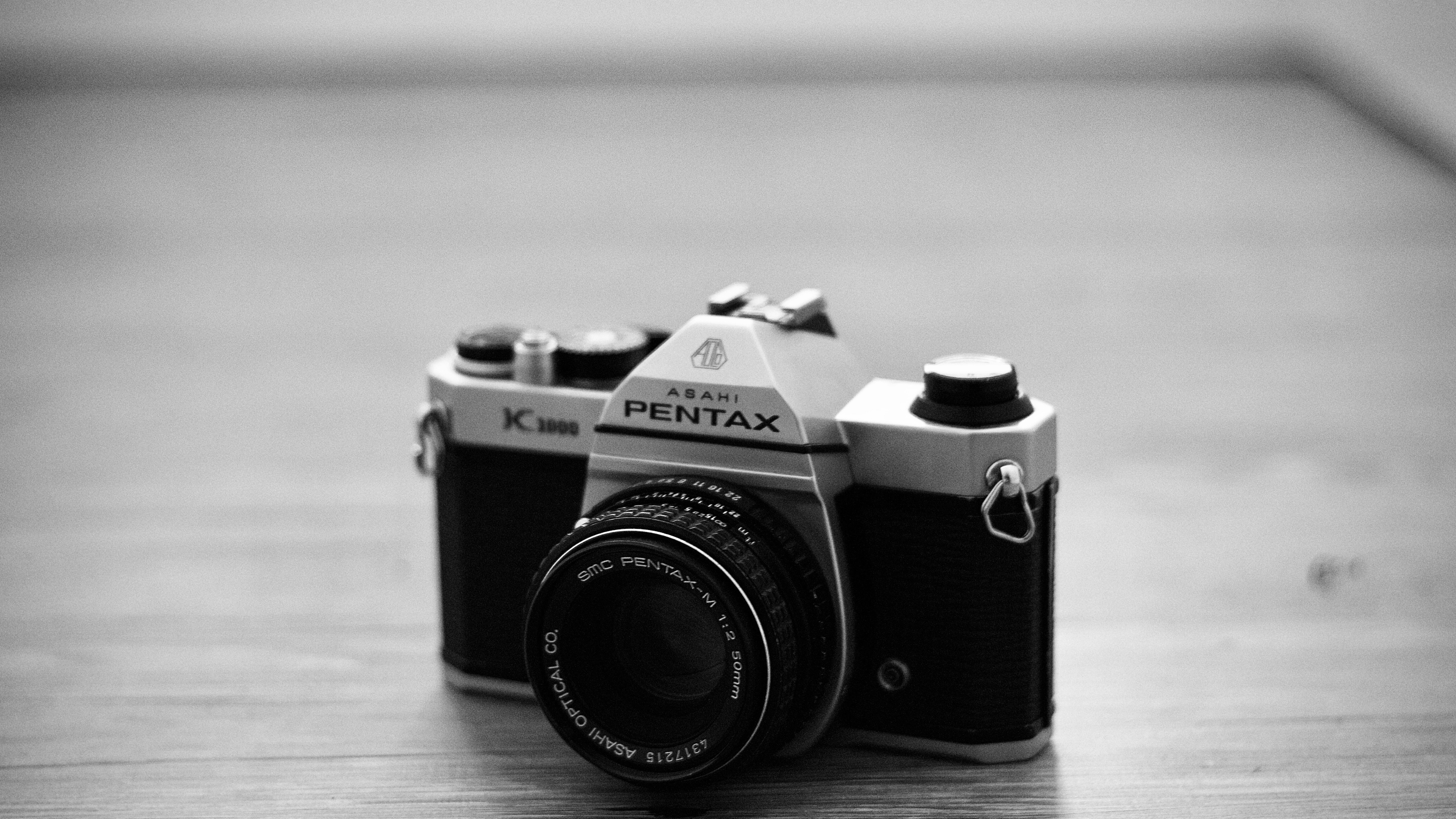 Quiet relic: a vintage Pentax camera rests on a weathered wooden desk