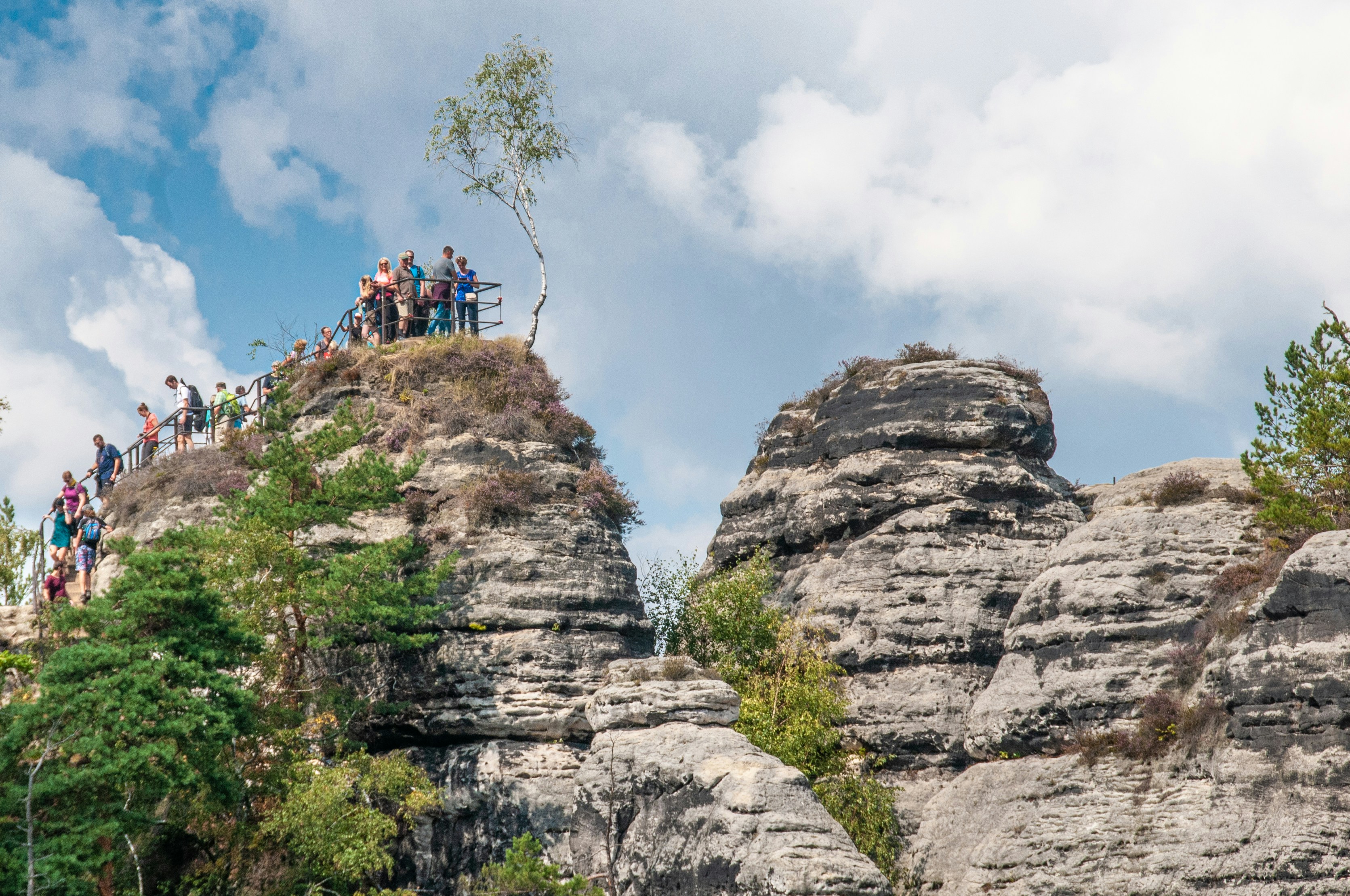 People standing on rock formation photo – Free Cliff Image on Unsplash