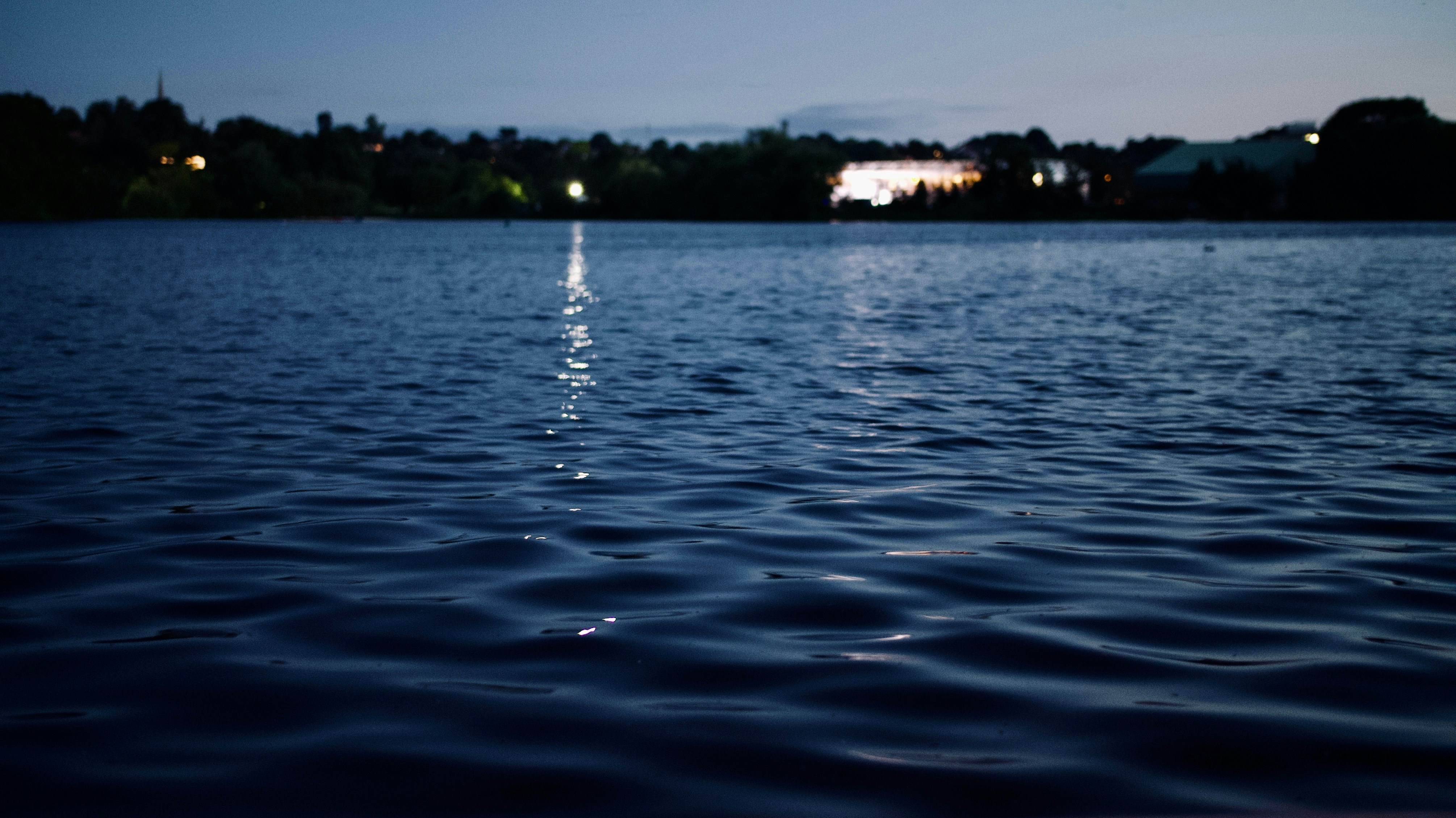 Moonlit Synapse: Distant Shoreline Ripples Across Quiet Water