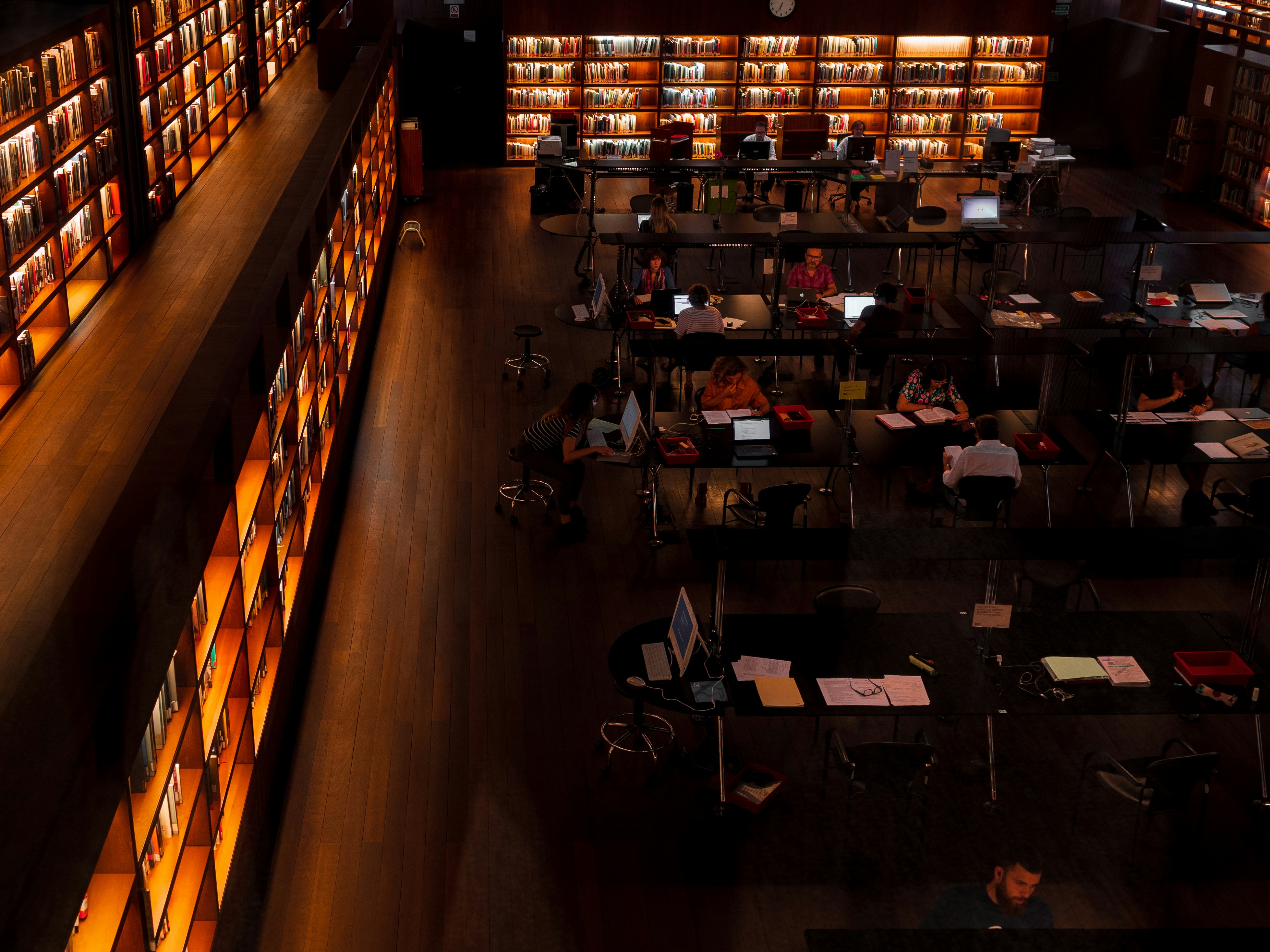 People inside library beside tables photo – Free Brown Image on Unsplash