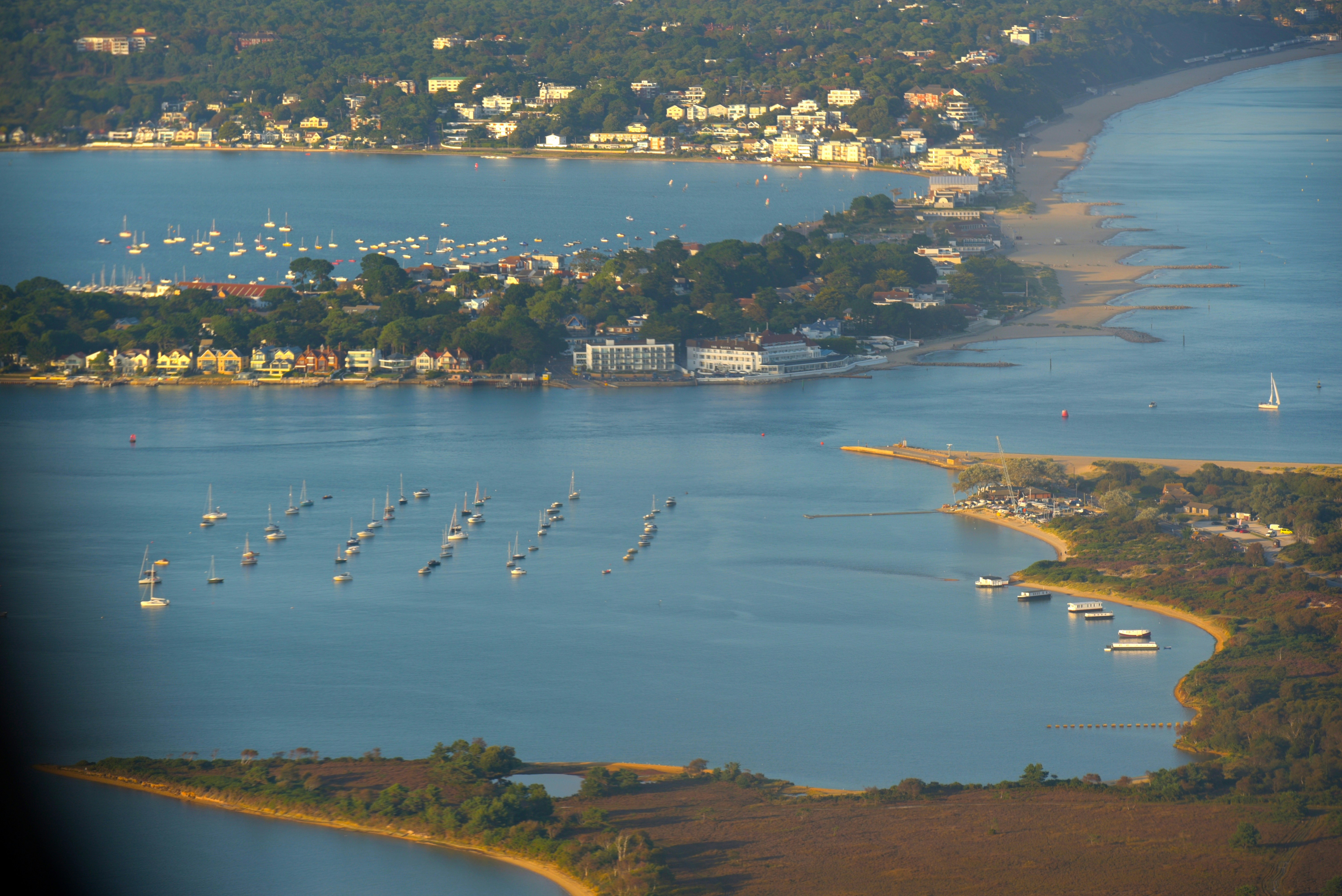 Boats on water near island photo – Free Outdoors Image on Unsplash