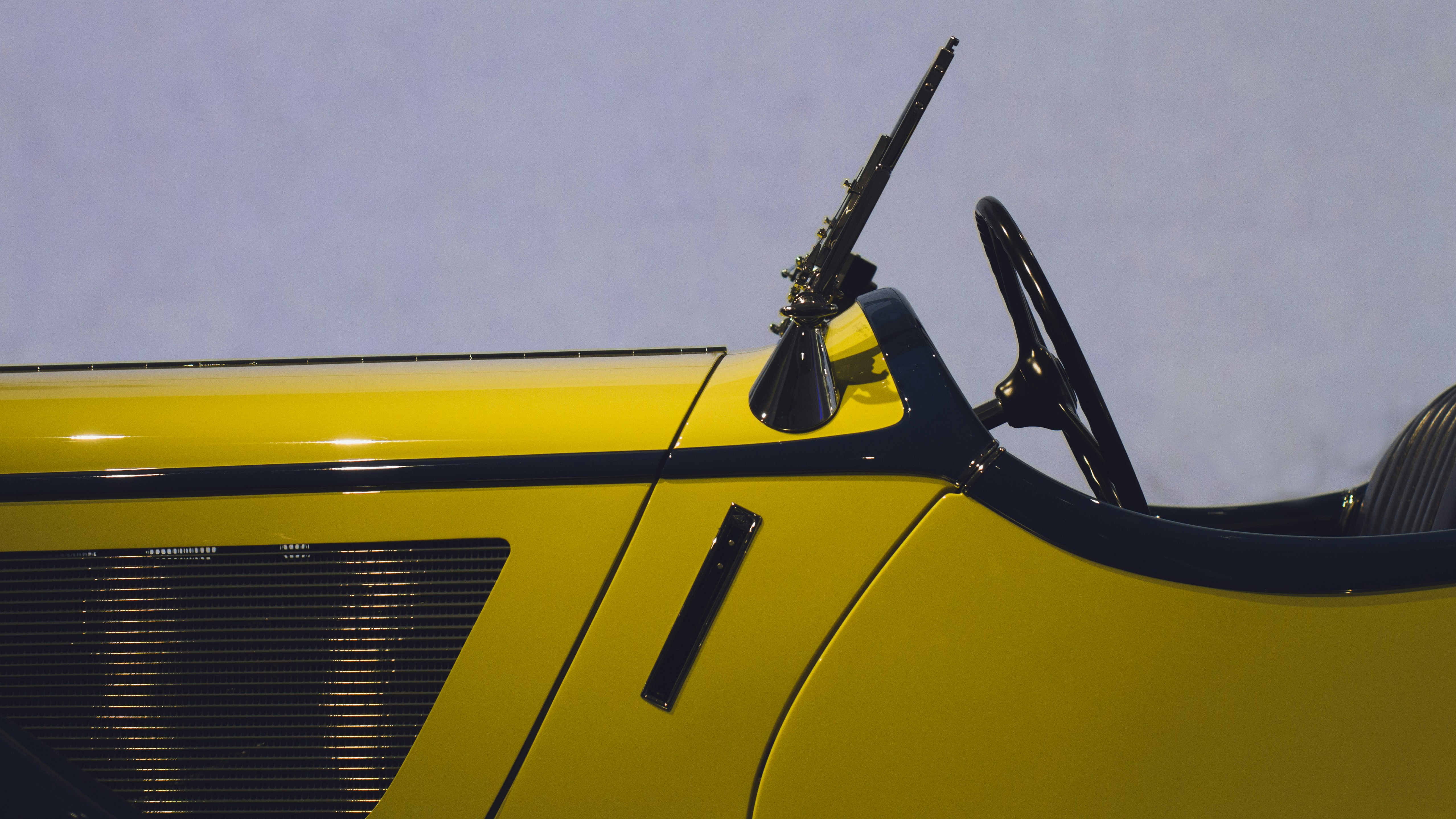 a close up of the front of a yellow car