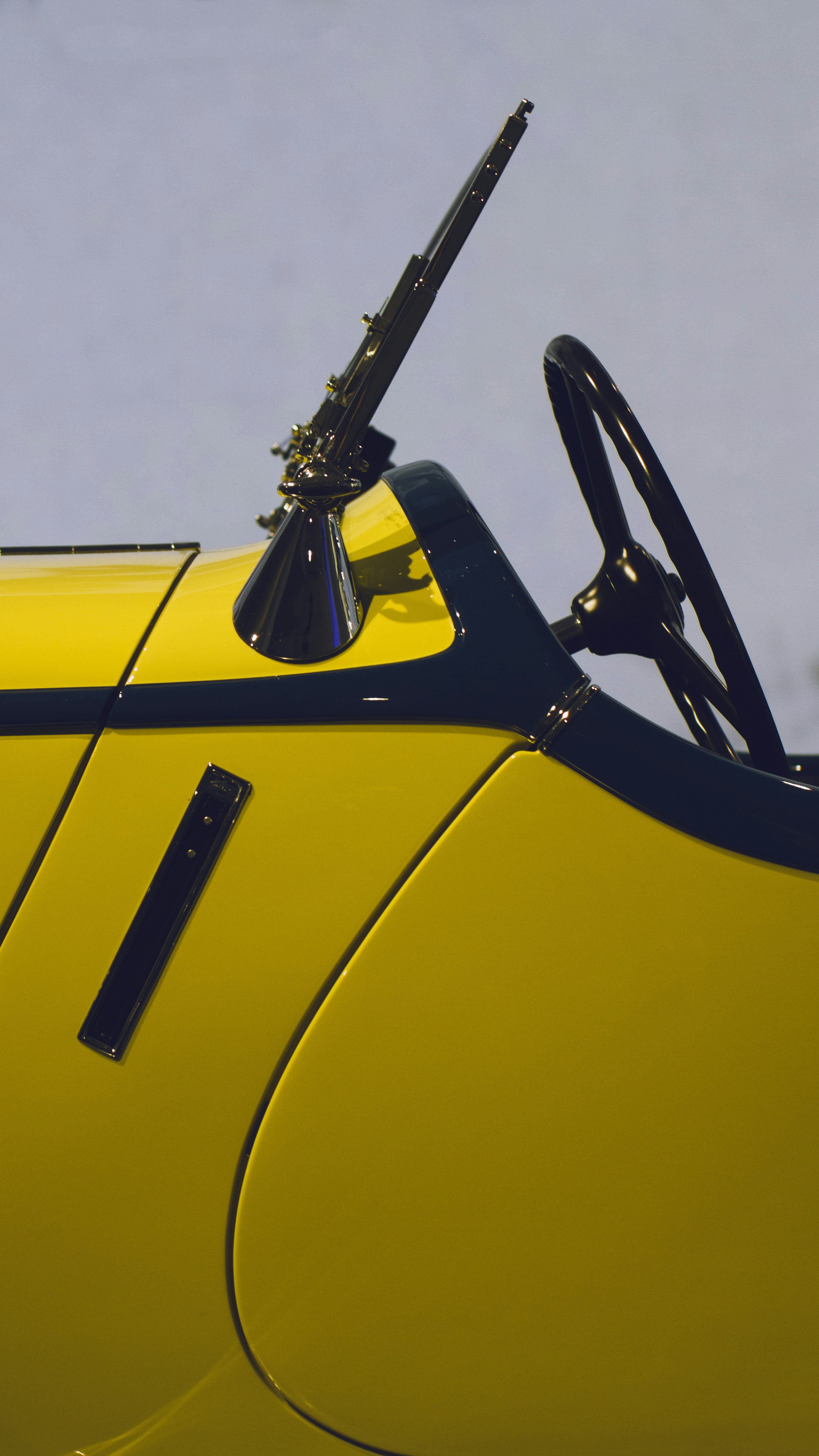 a yellow car with a black steering wheel