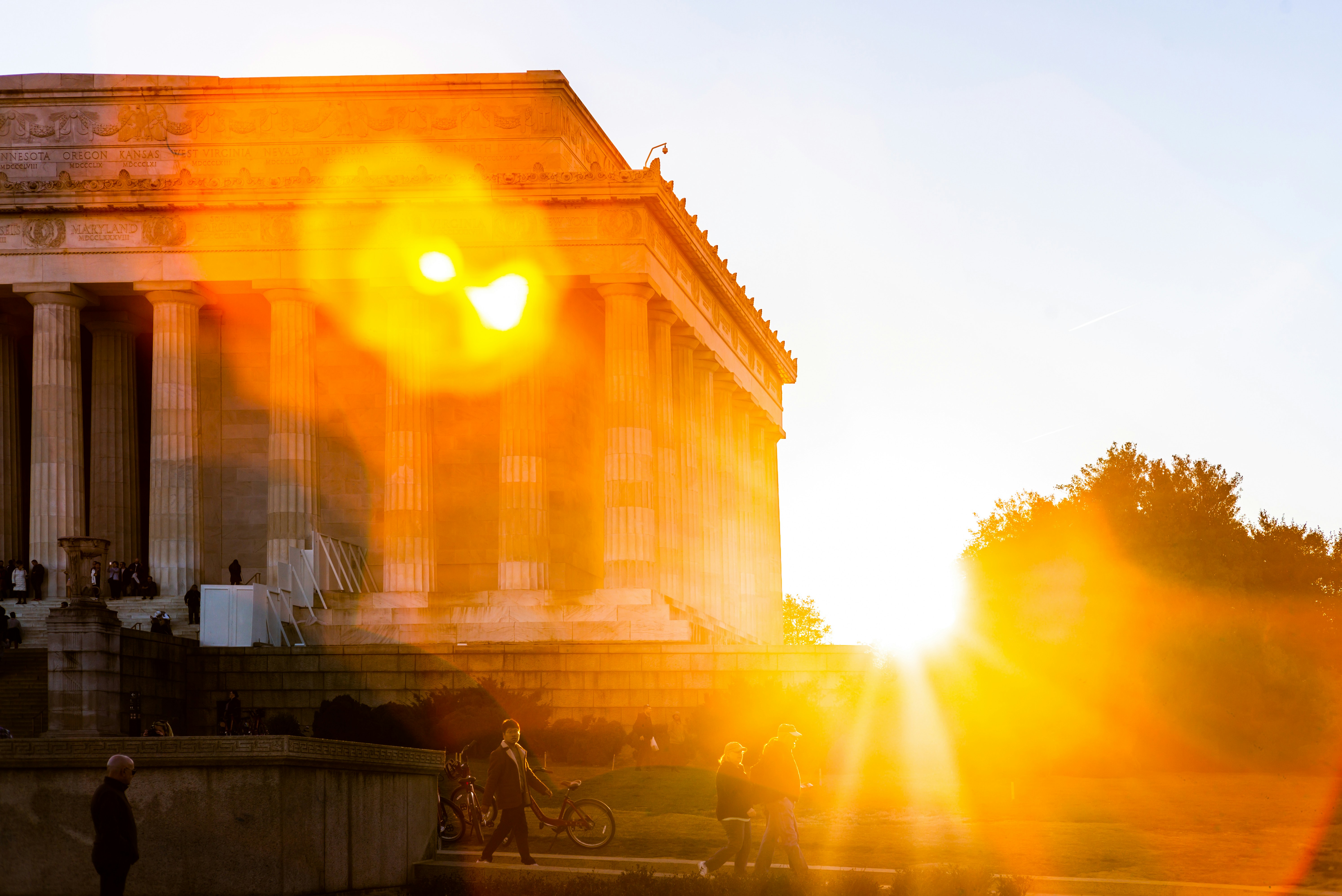 Lincoln Memorial with dramatic sunlight flare at sunset.