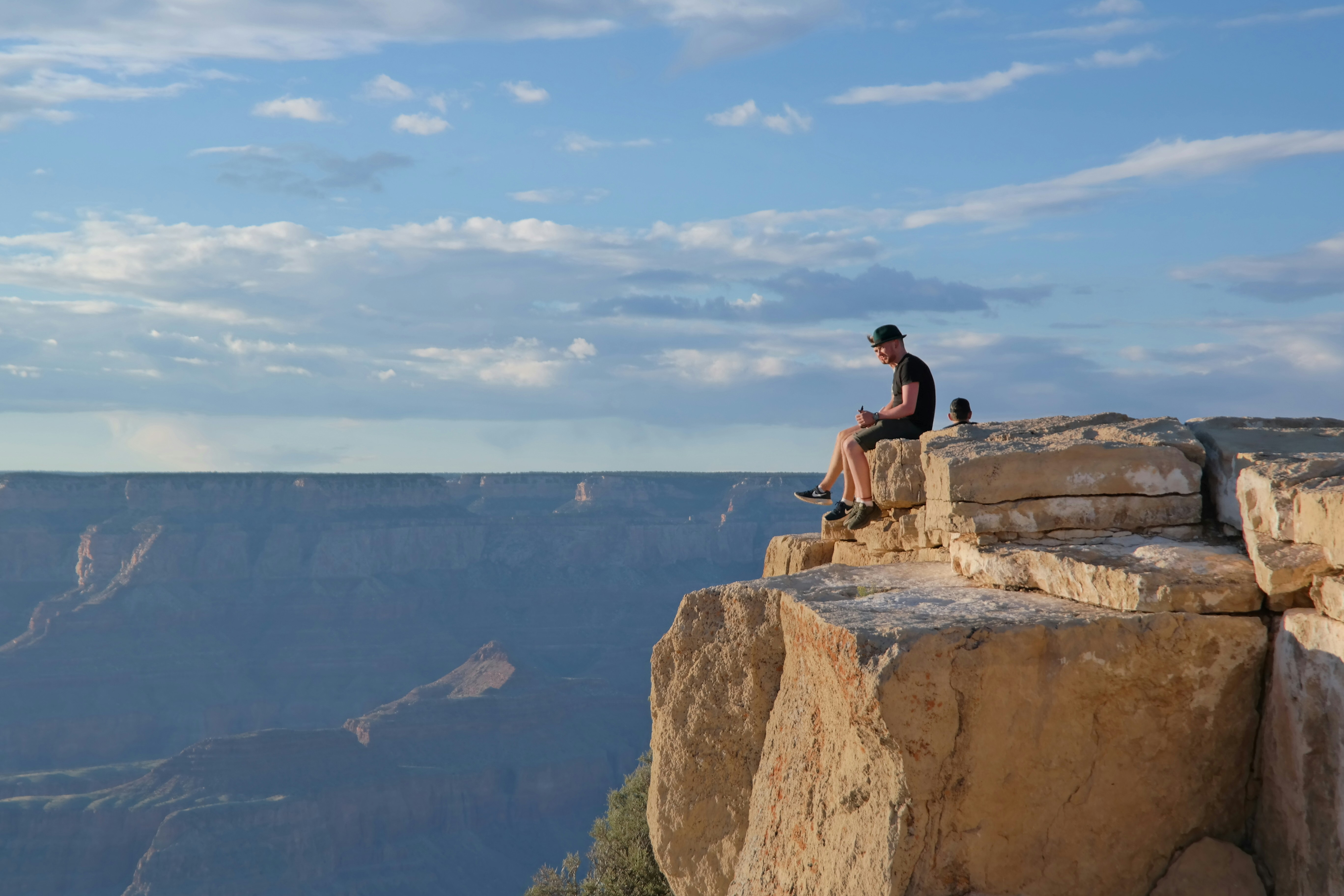 Man sitting on cliff photo – Free Grey Image on Unsplash