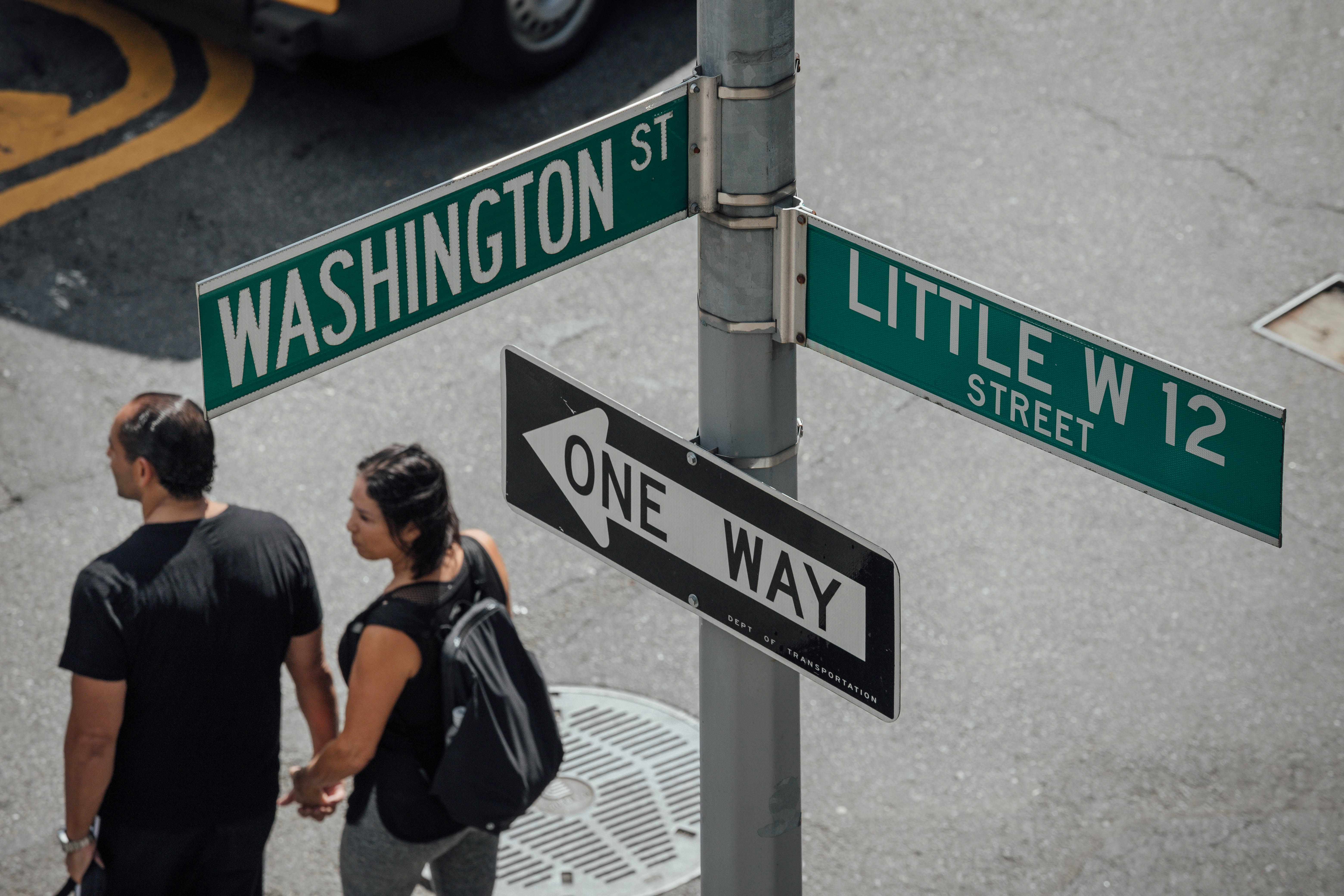 Man and woman standing near street sign photo – Free Grey Image on Unsplash