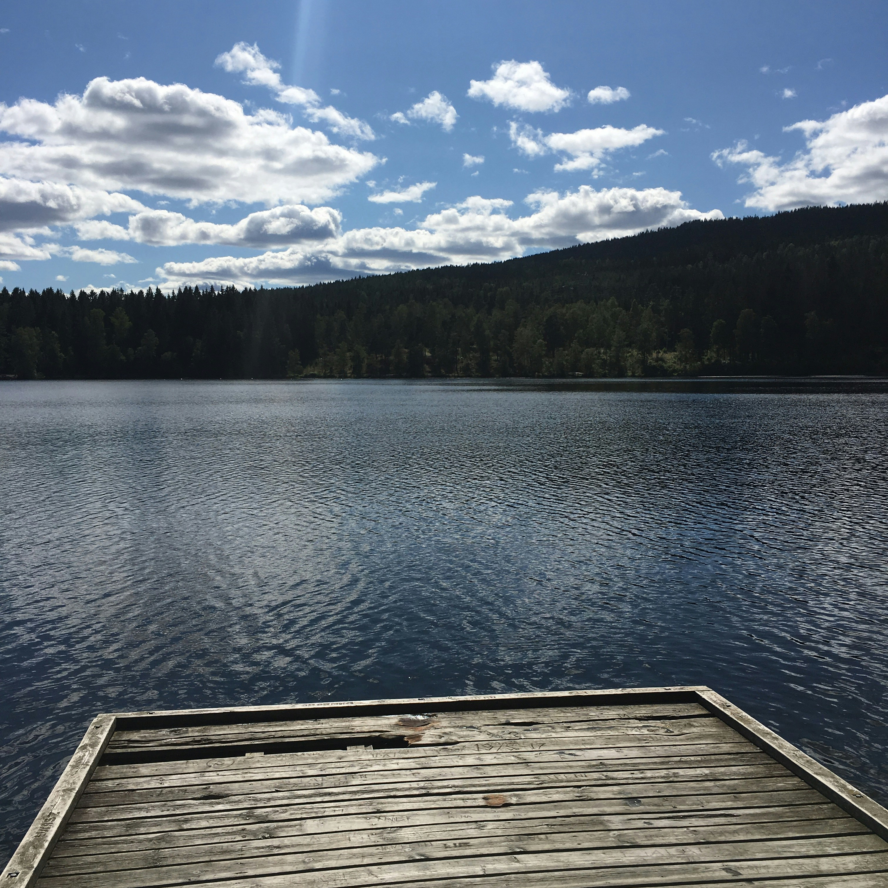 Timeworn Dock at the Edge of a Glassy Alpine Lake