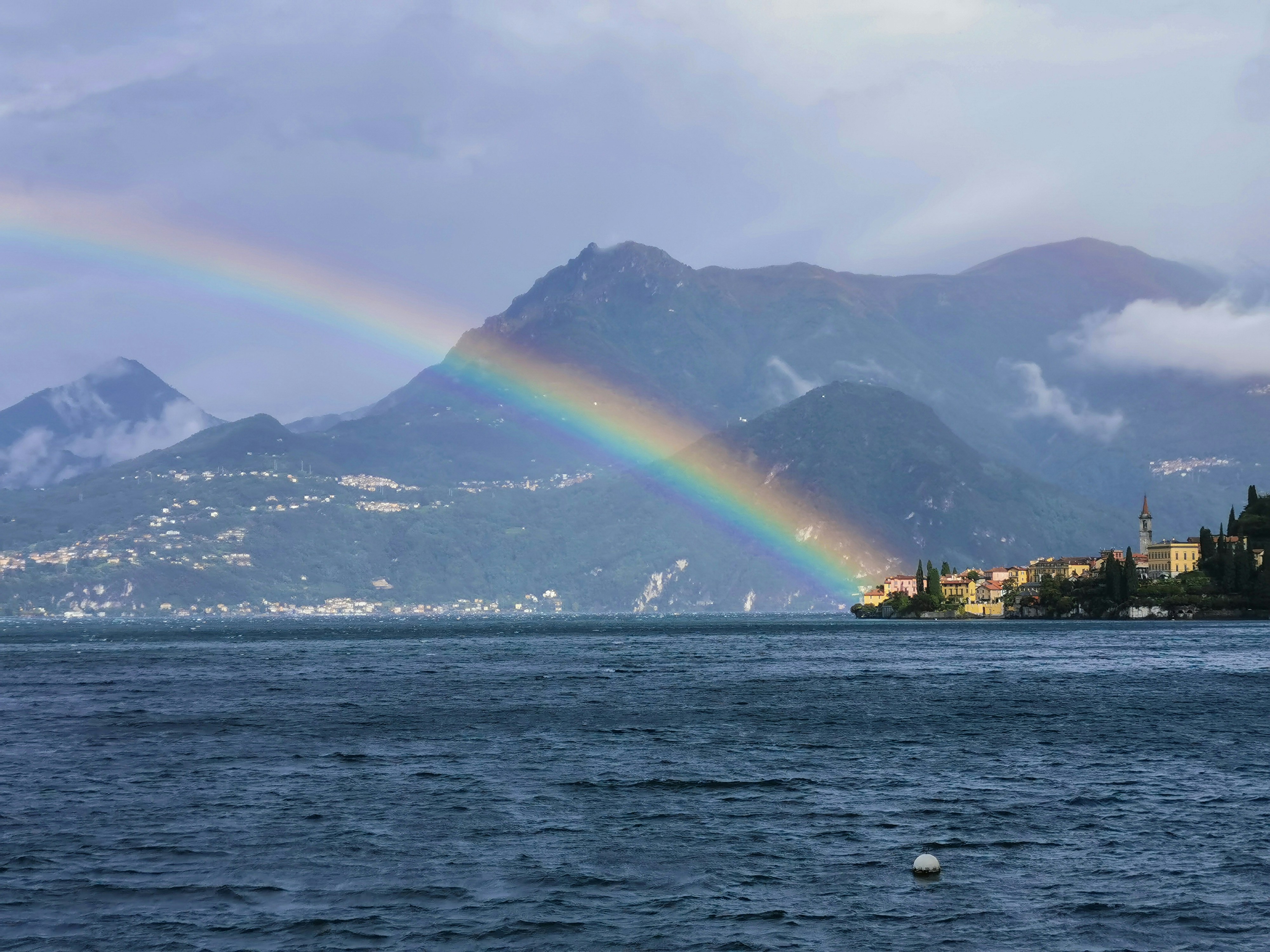 Rainbow over a mountain and blue sea photo – Free Grey Image on Unsplash
