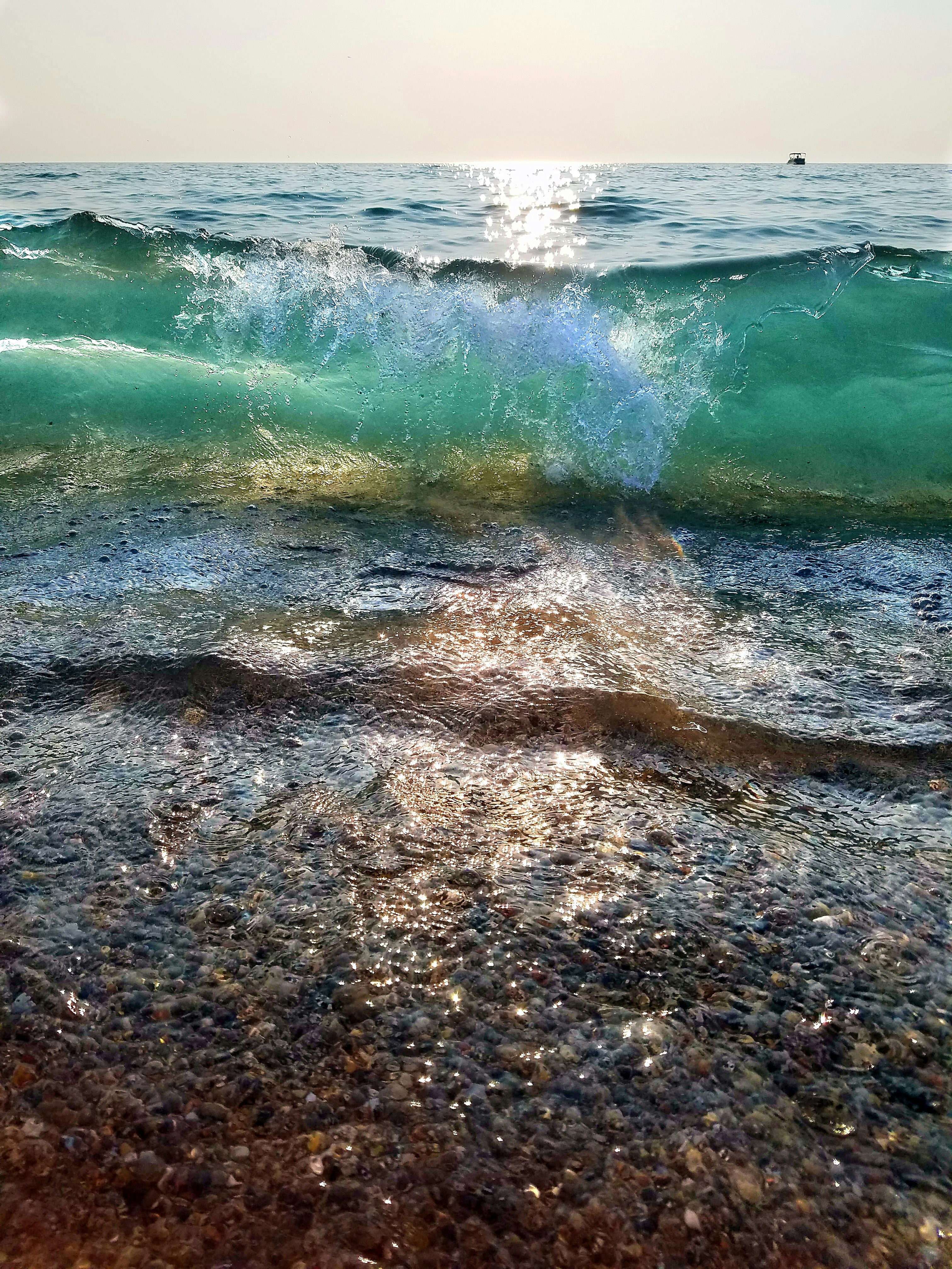 Turquoise Crest Over Pebble Shore at Golden Hour