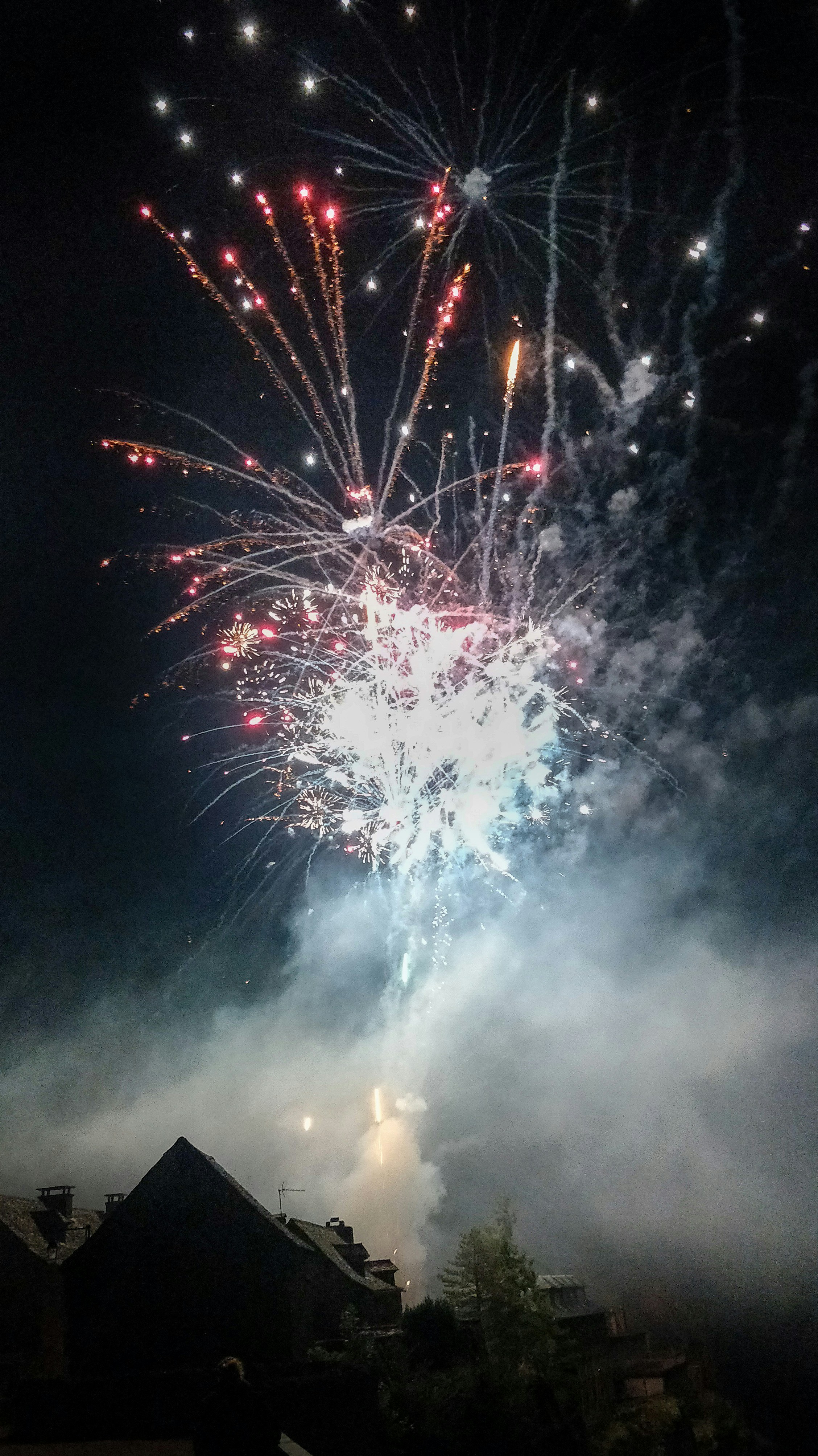 Fog-Wreathed Night Fireworks Over a Quiet Village