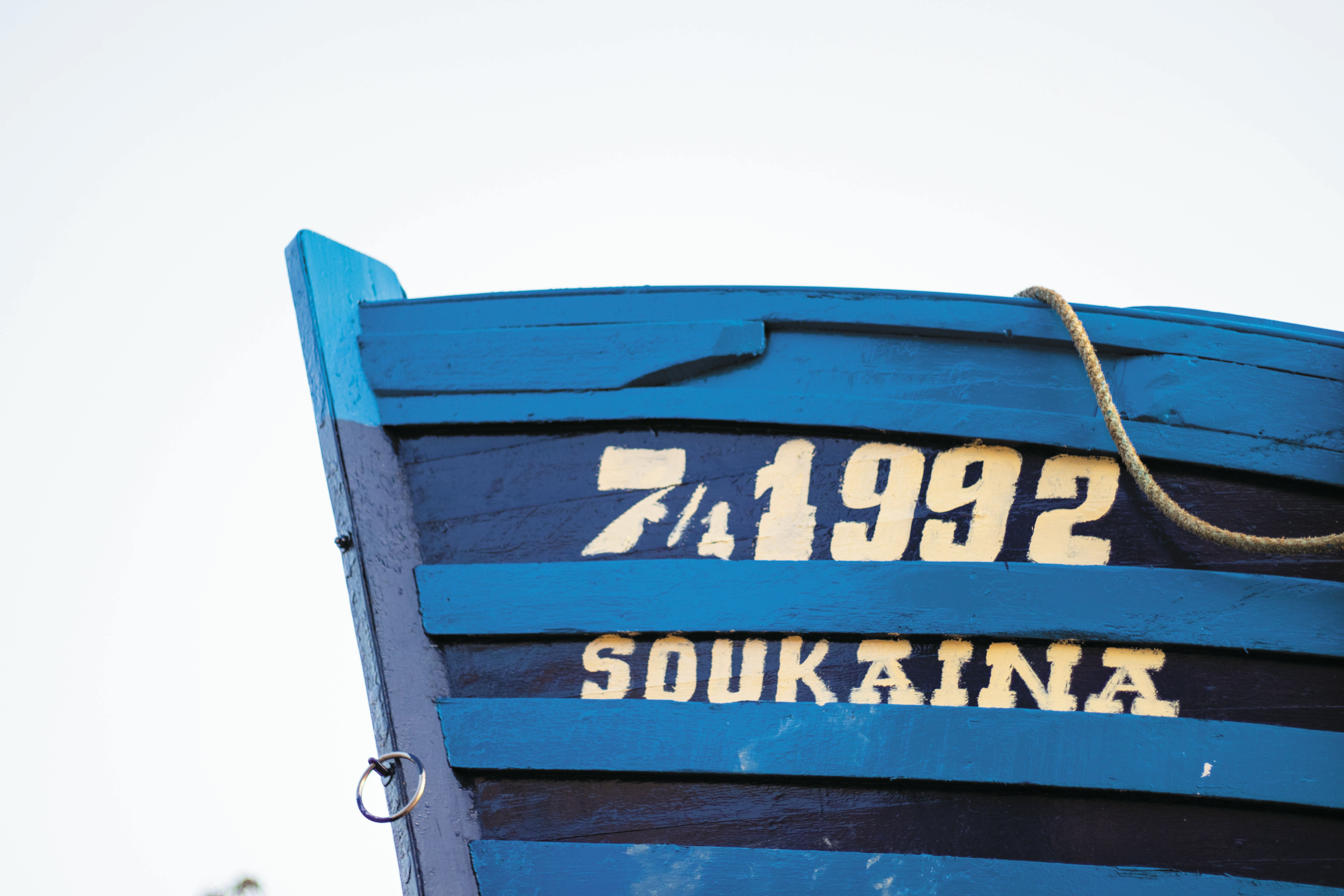 Blue Hull Portrait: Weathered Signage and a Lone Rope
