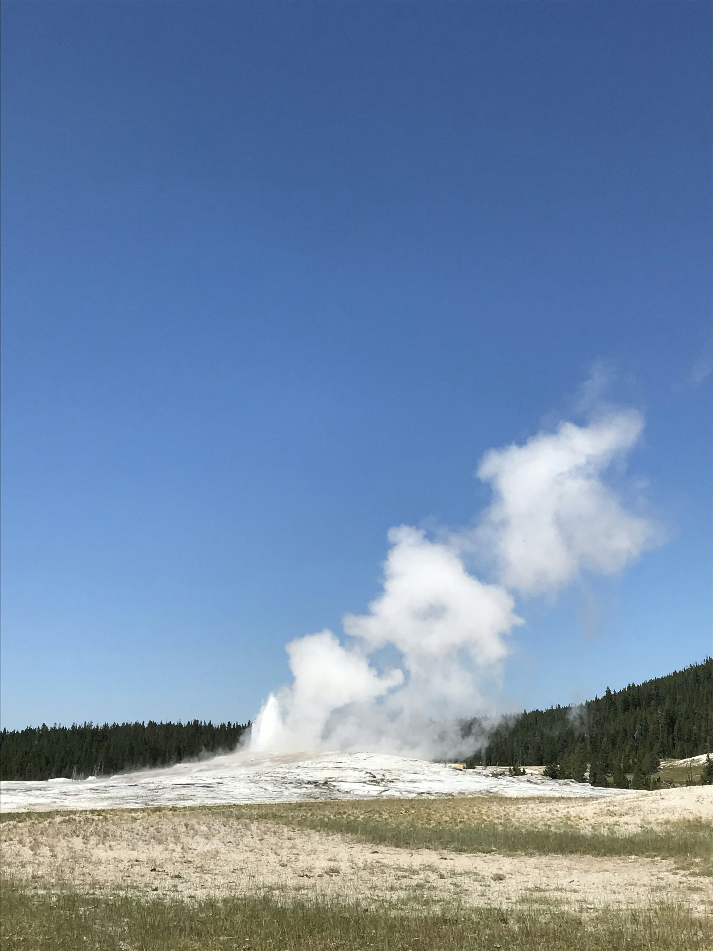 Steam Spiral over a Snow-Dusted Plain Beneath a Clear Blue Sky