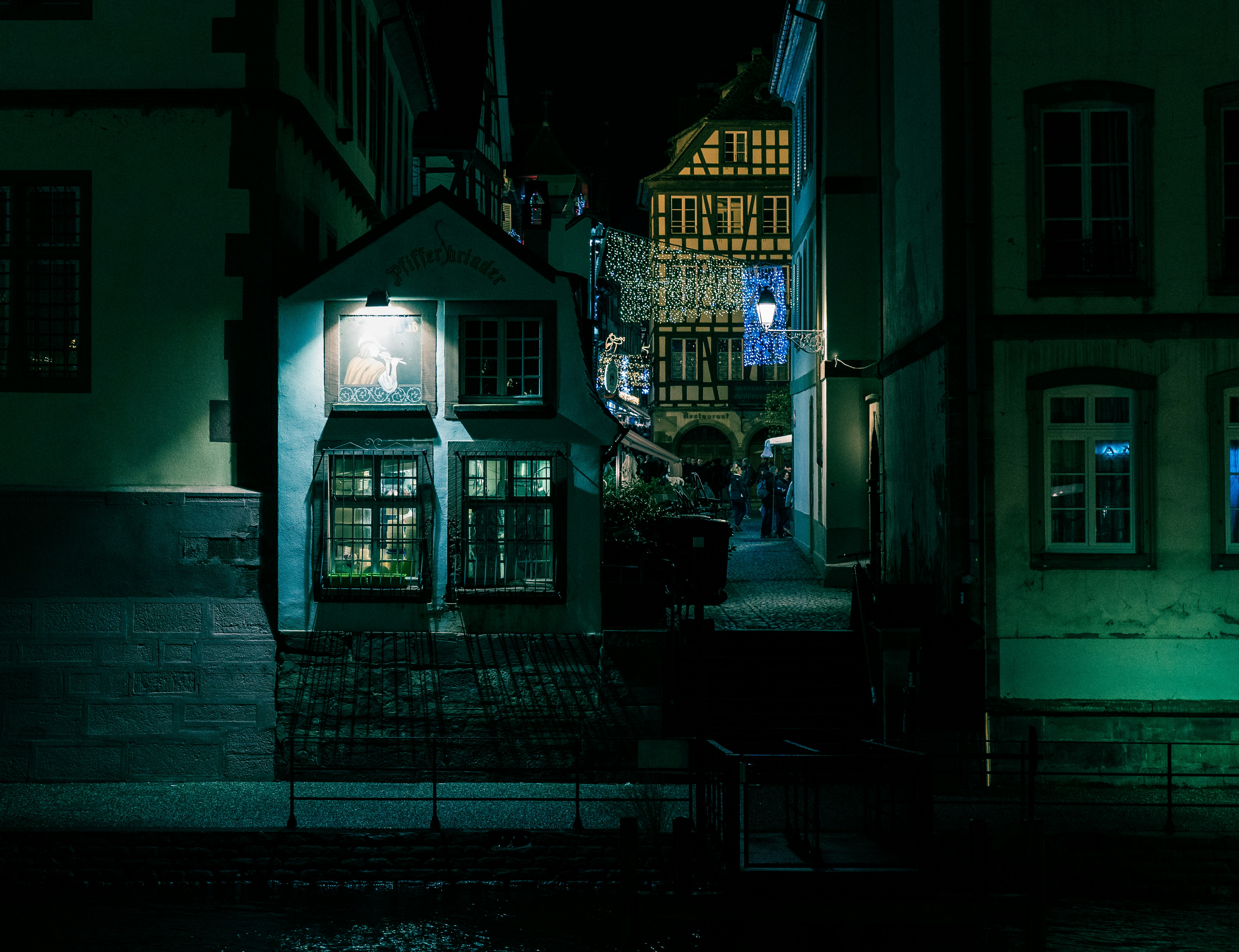 A dark alleyway with a small store at night photo – Free Grey Image on ...