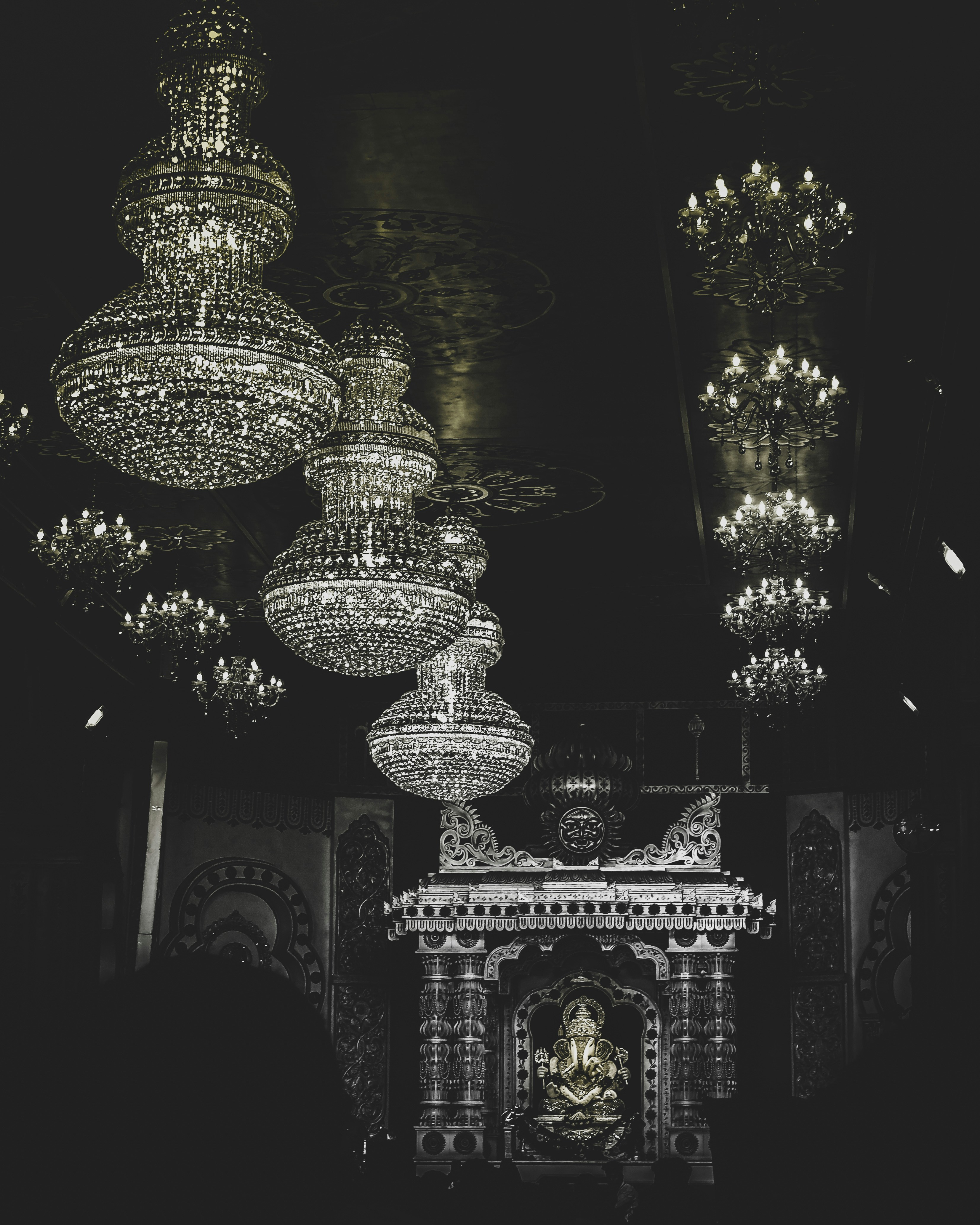 Chandeliered Shrine: A Dim, Ornate Hall Framed by Glittering Orbs