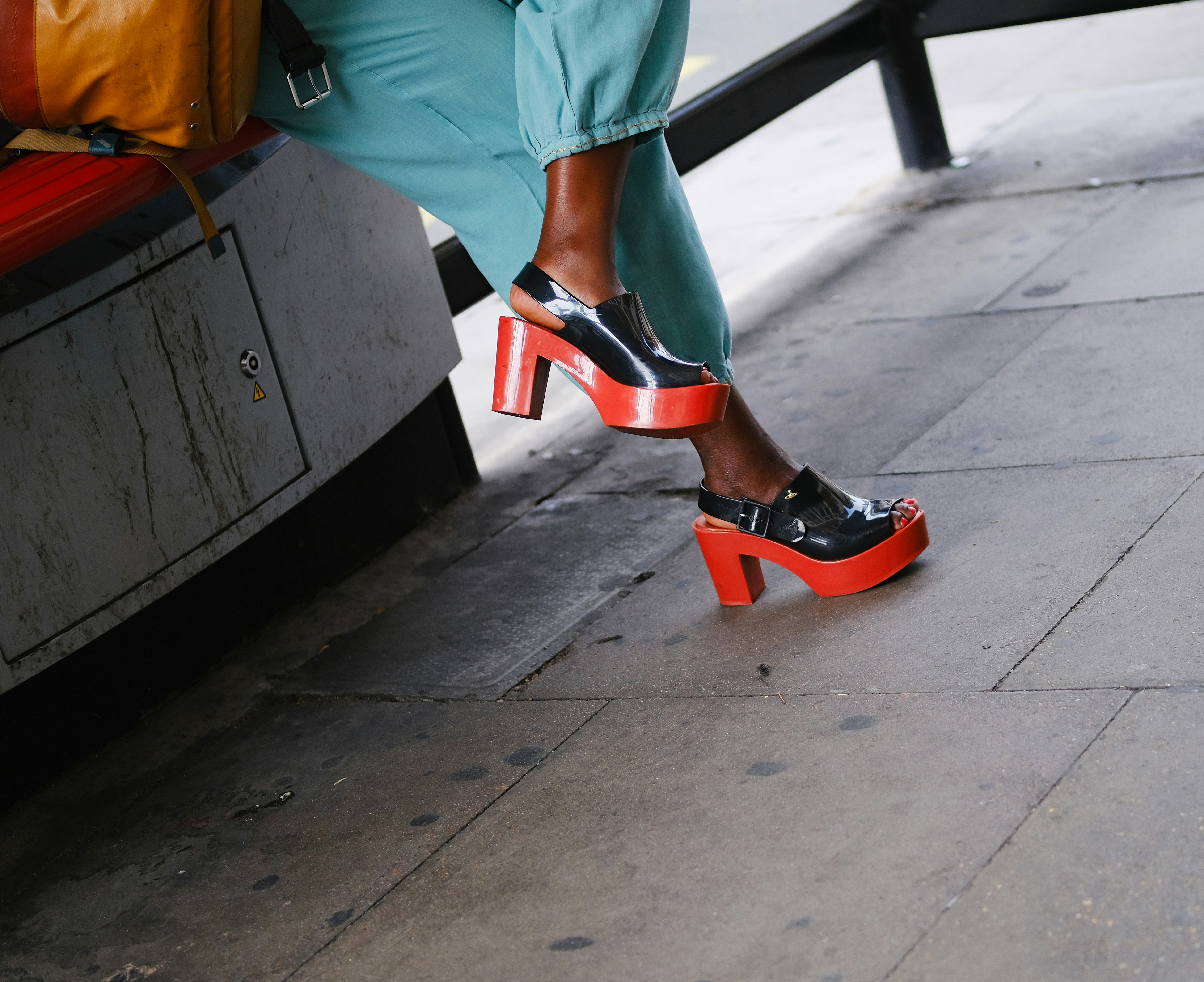 Platform Power: Bright Orange Heels Lift a City-Street Moment