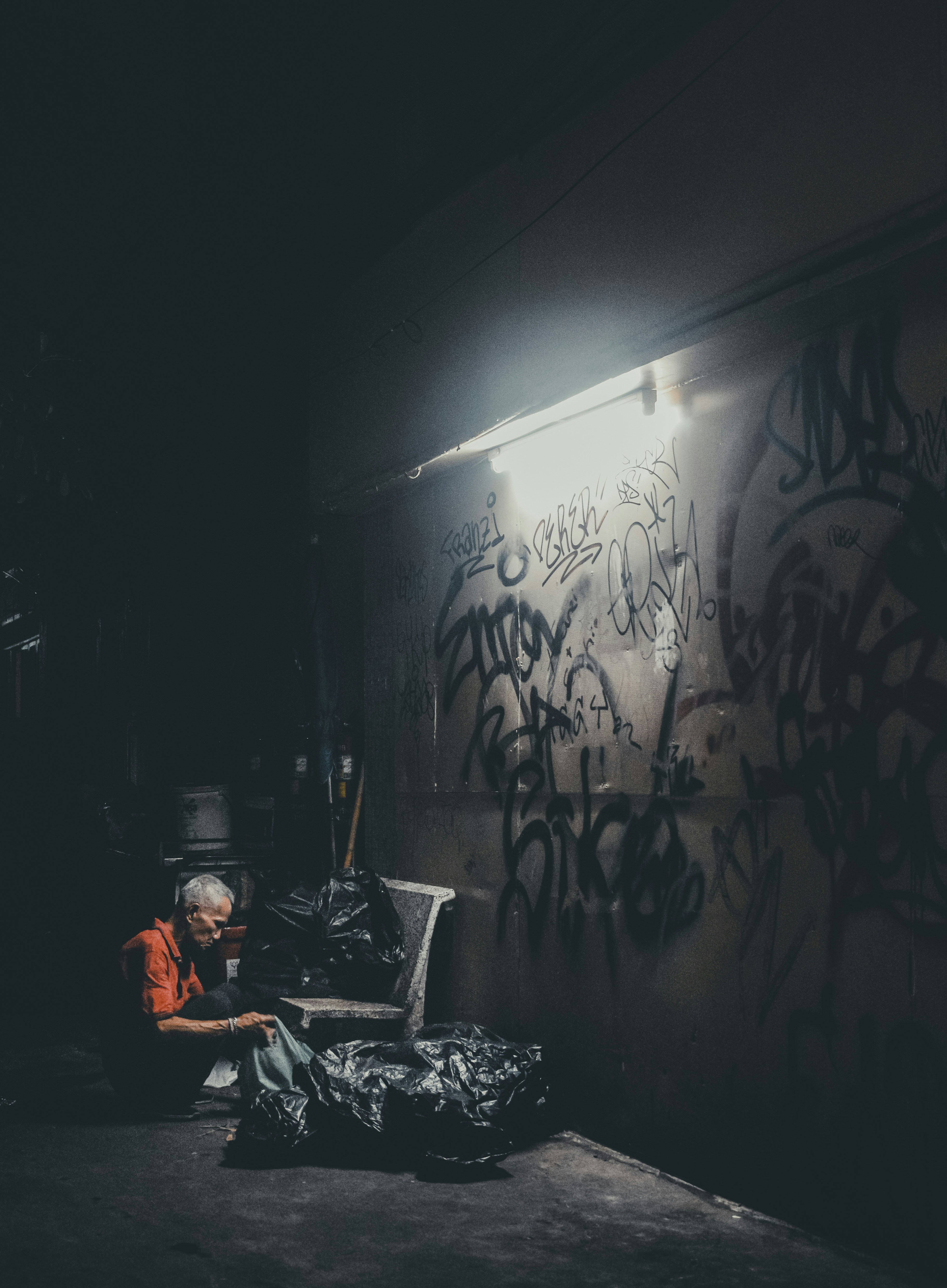 Orange in the Shadowed Alley: A Quiet Portrait Beneath Graffiti Glow