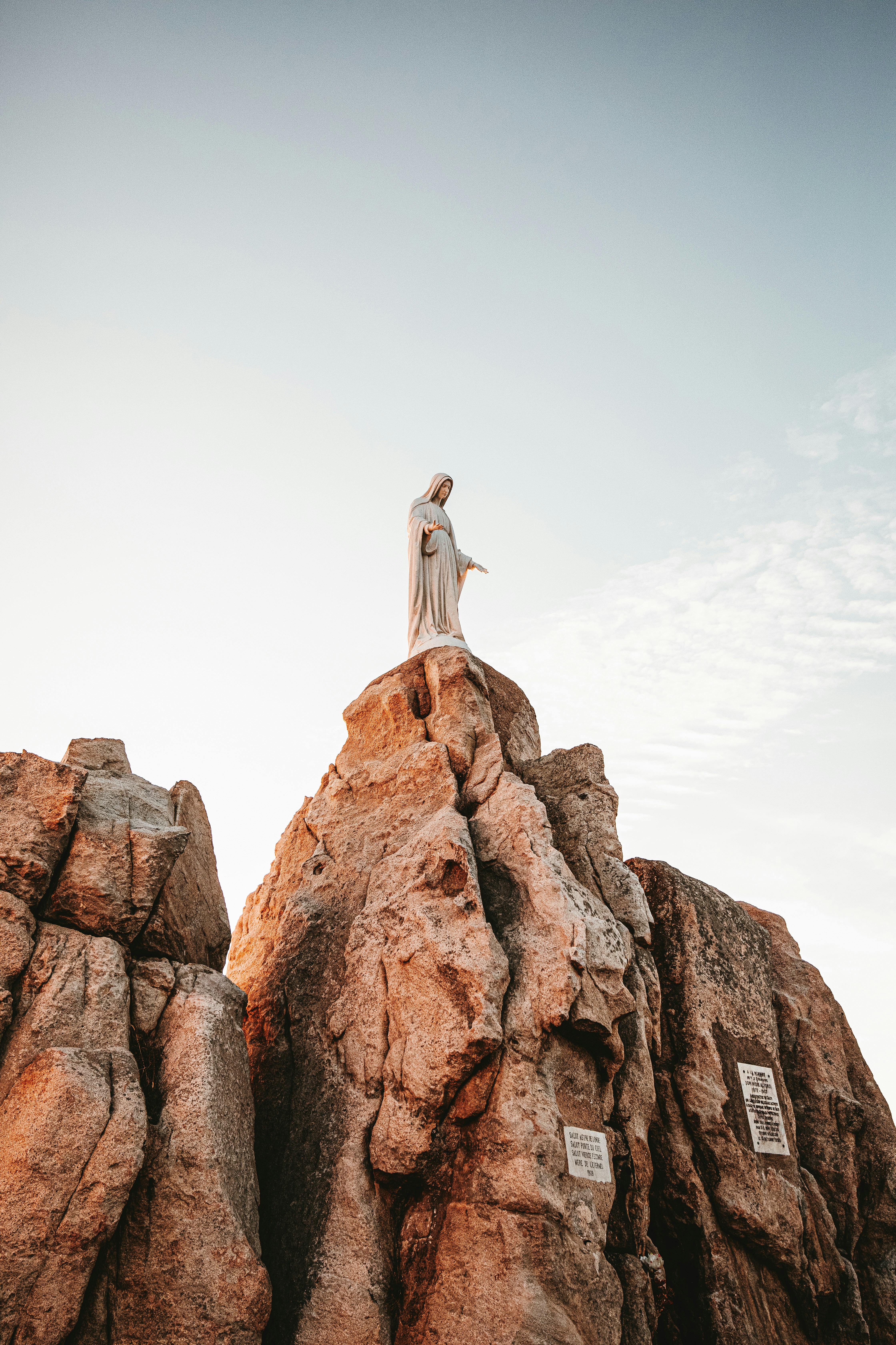 Crepuscular Sentinel: A solitary statue crowns wind-worn granite spires