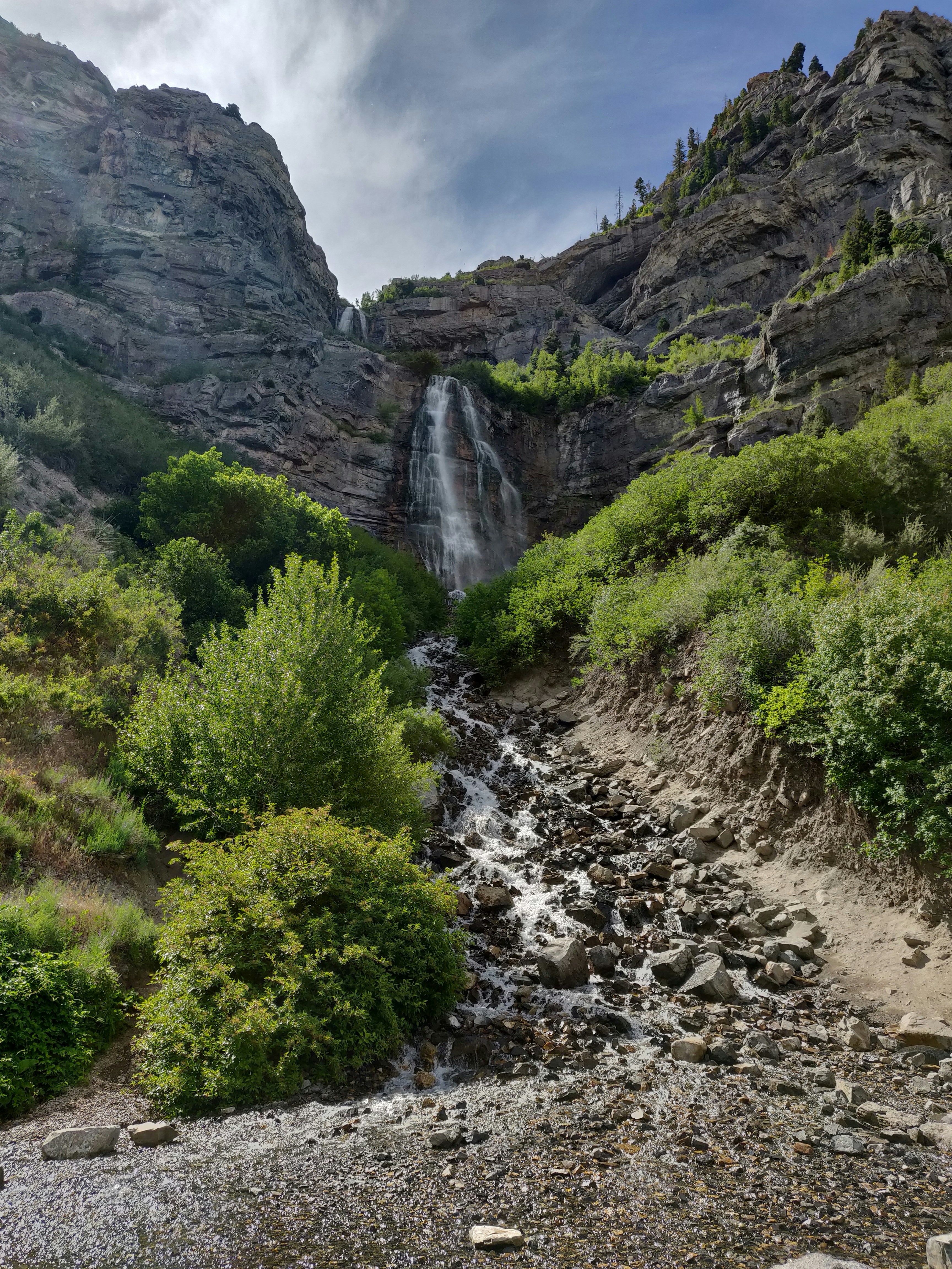 Rocky mountain waterfalls near plants during day photo – Free Green ...