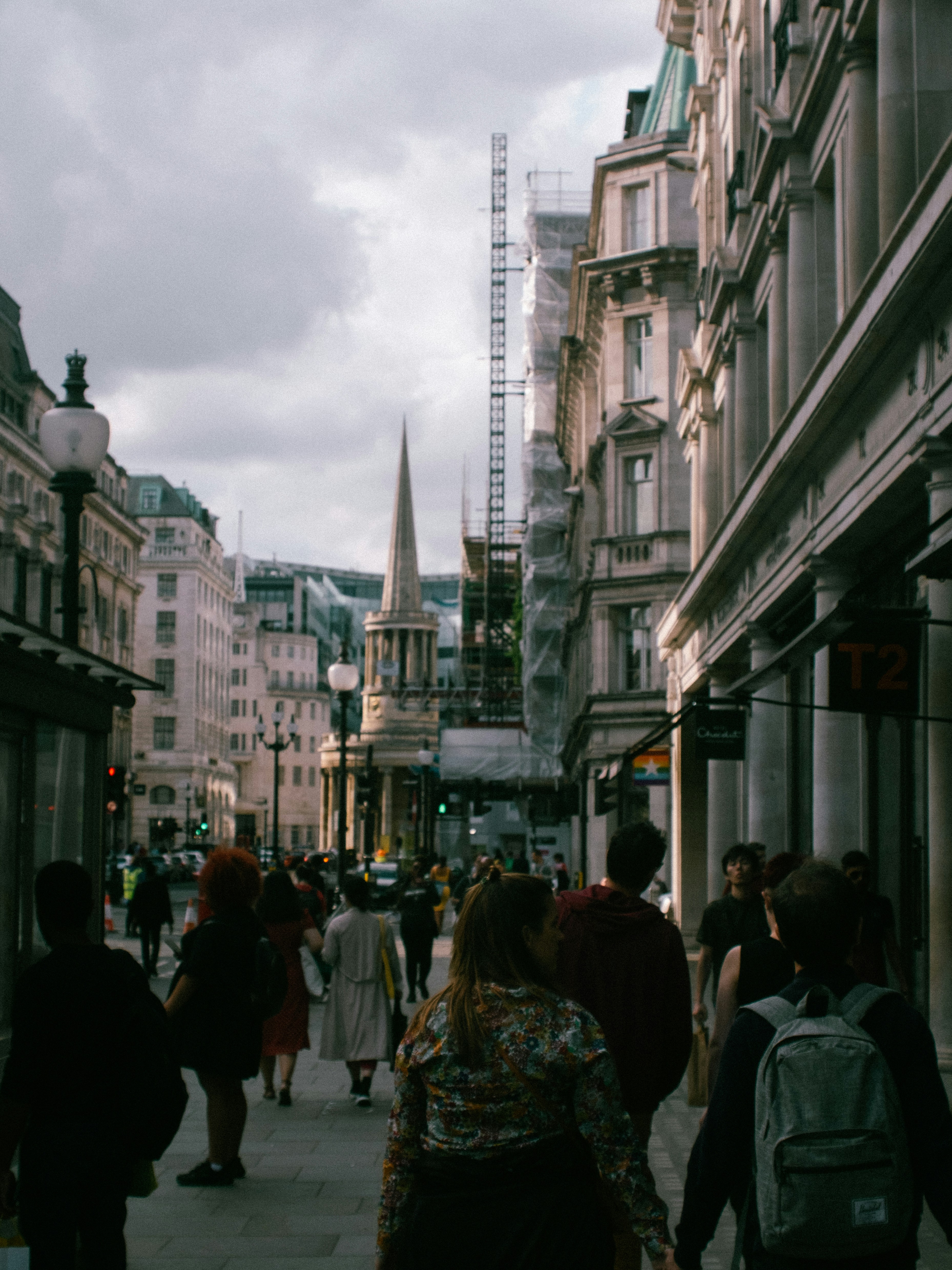 Crowds on a Narrow City Street Converge Toward a Distant Spire