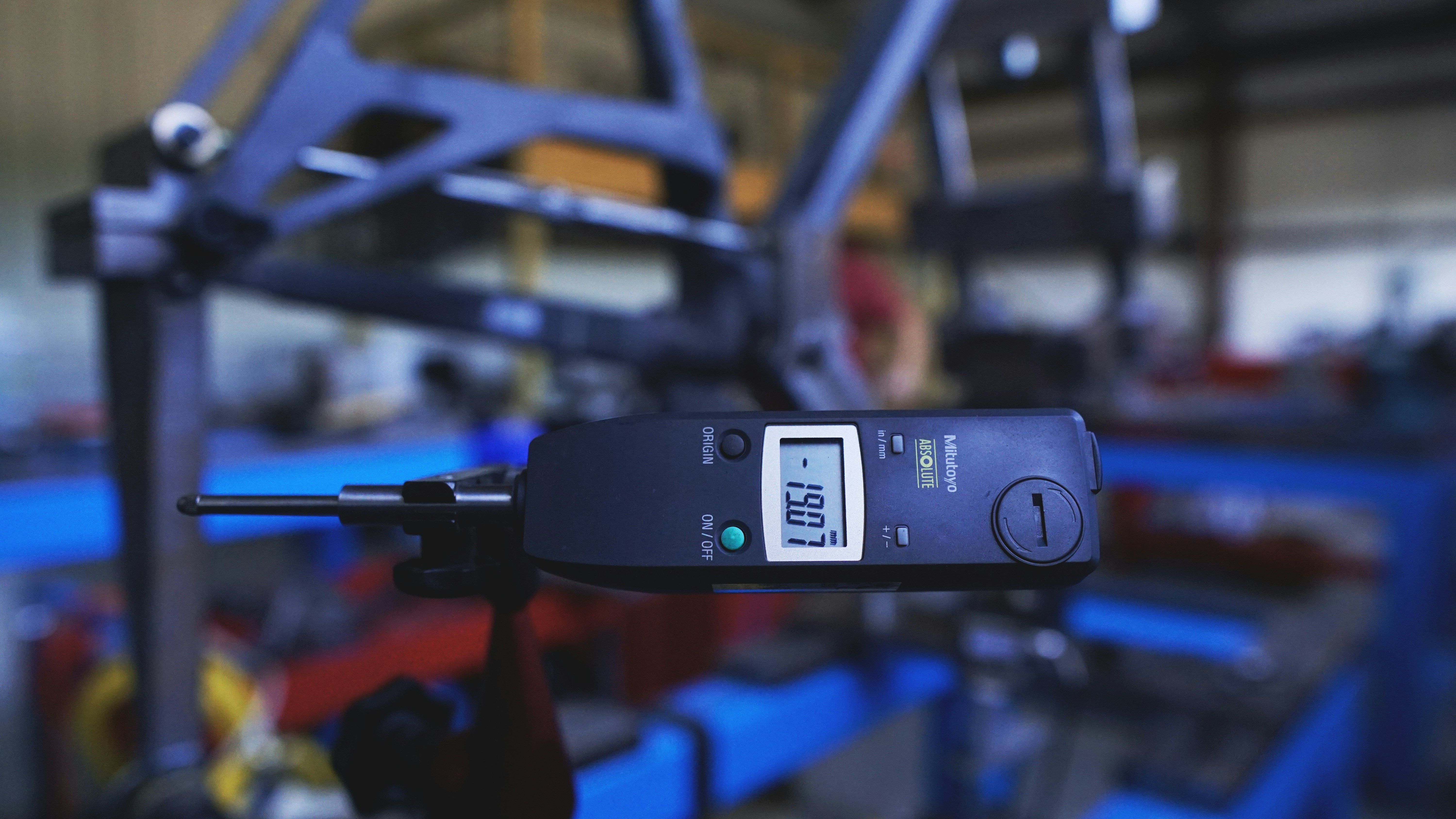 Close-Up Gauge on a Blue Industrial Frame: Precision in a Workshop